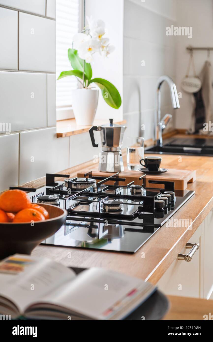 Modern kitchen in white with cooking hob Stock Photo - Alamy