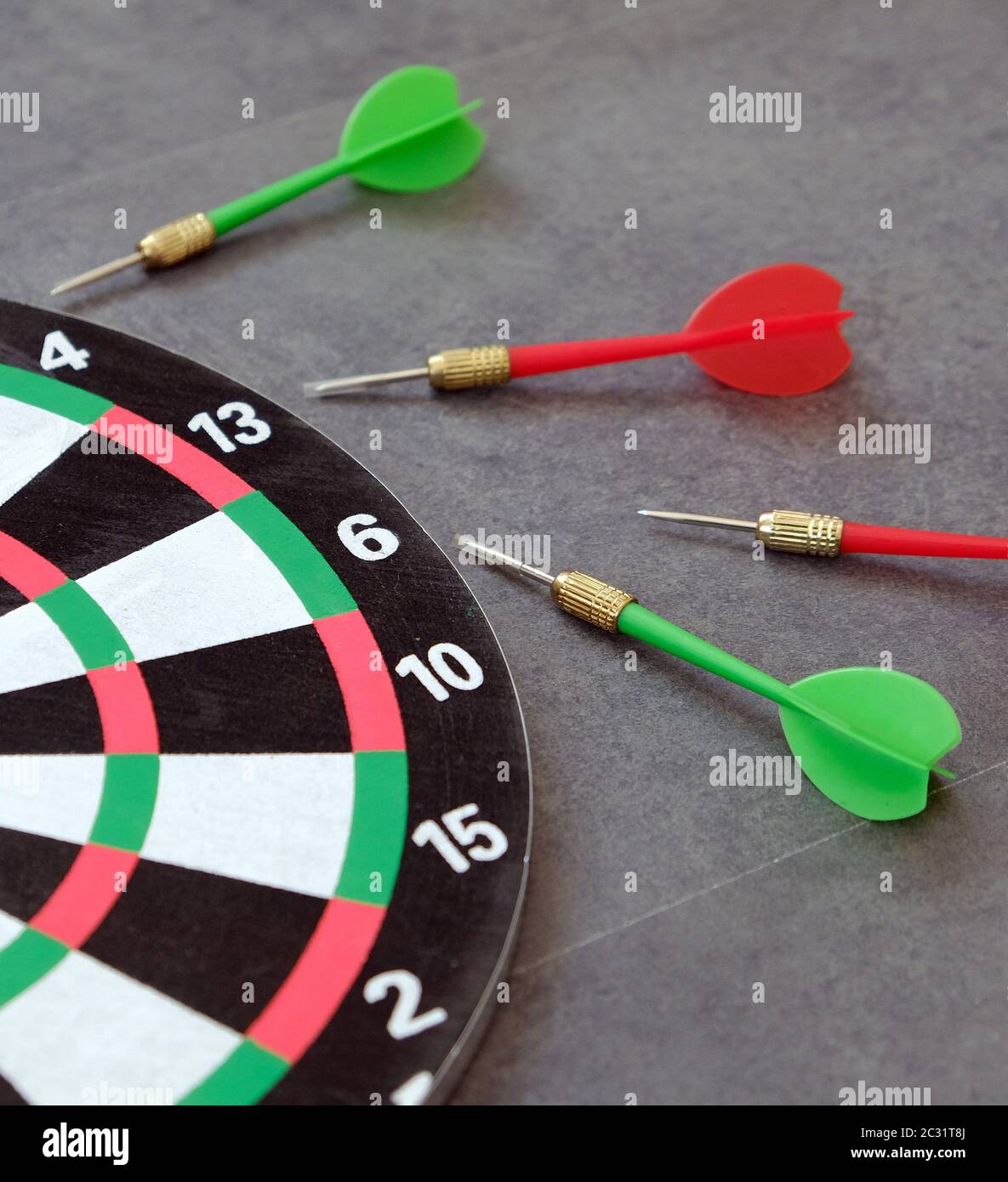 dartboard and dart arrows standing on black groundbdart arrow stuck and ...