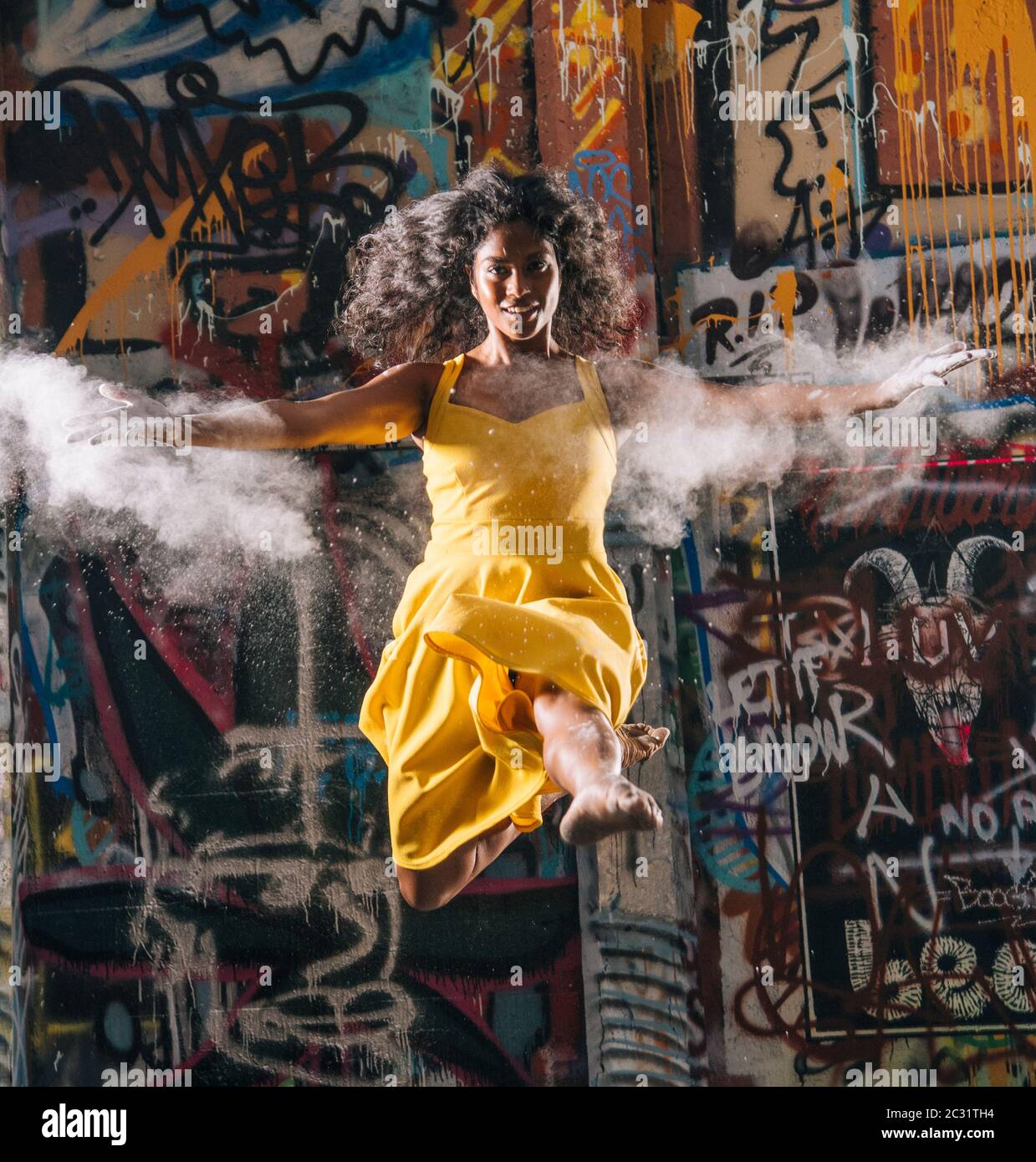 View of modern dancer and graffiti on background Stock Photo - Alamy