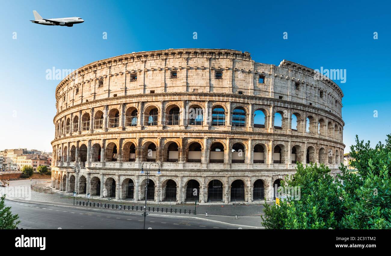 Airplane Flying In Clear Blue Sky Over Leaning Tower Of Coliseum In ...