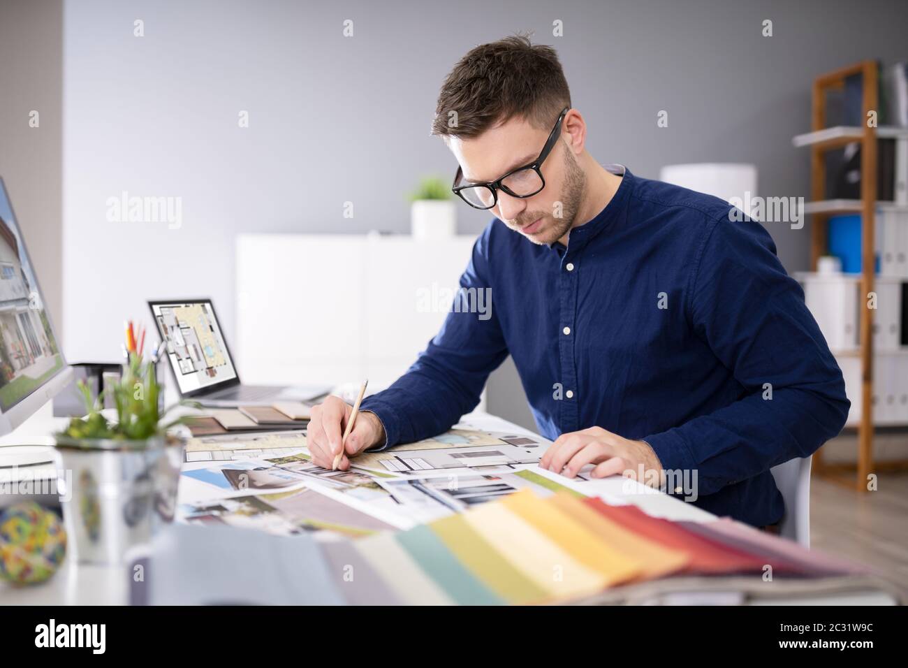 Side View Of Real Estate Designer Working On Computer In Office Stock ...