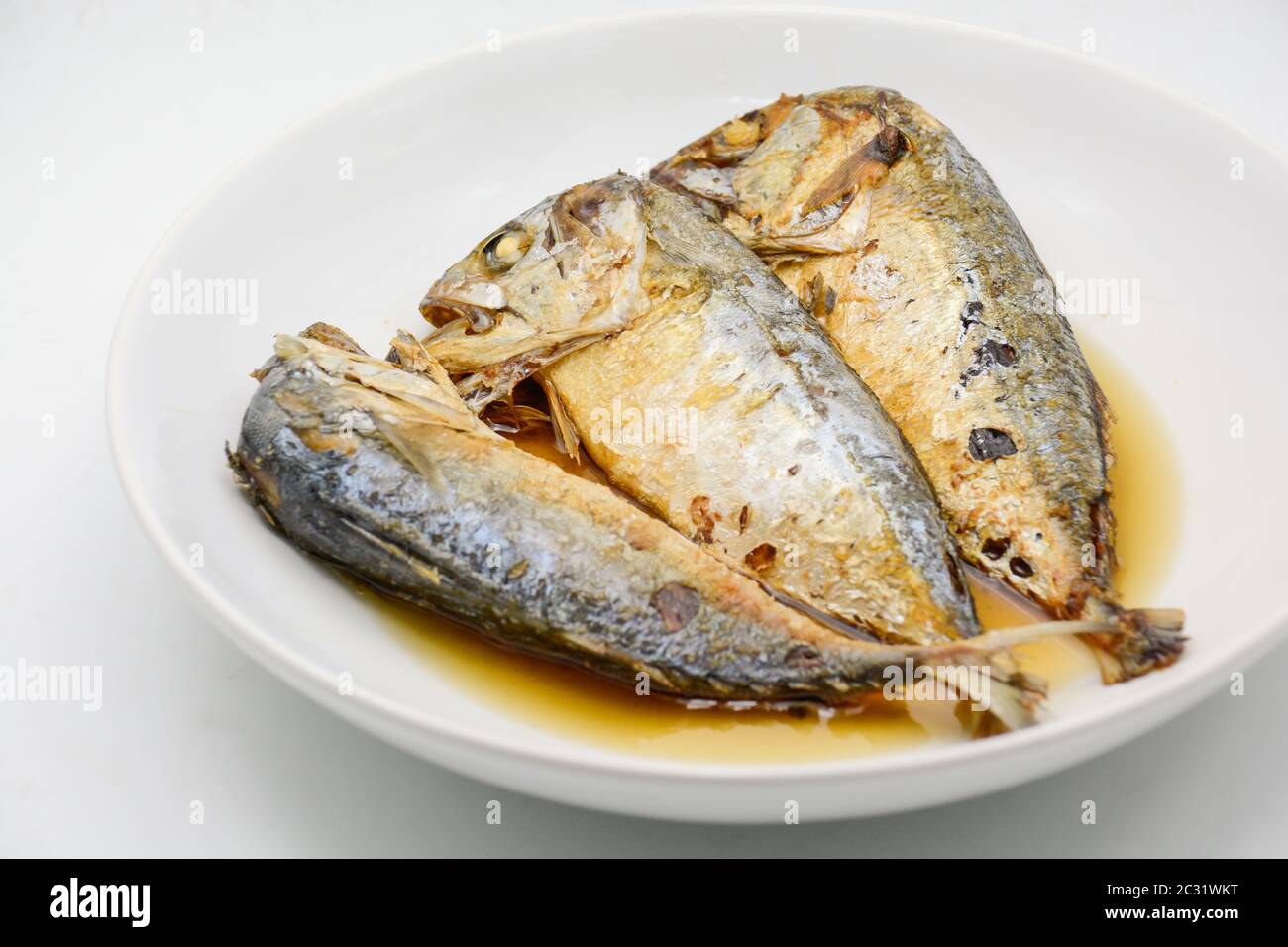 Fried mackerel on white plate. Deep fried fish Stock Photo - Alamy