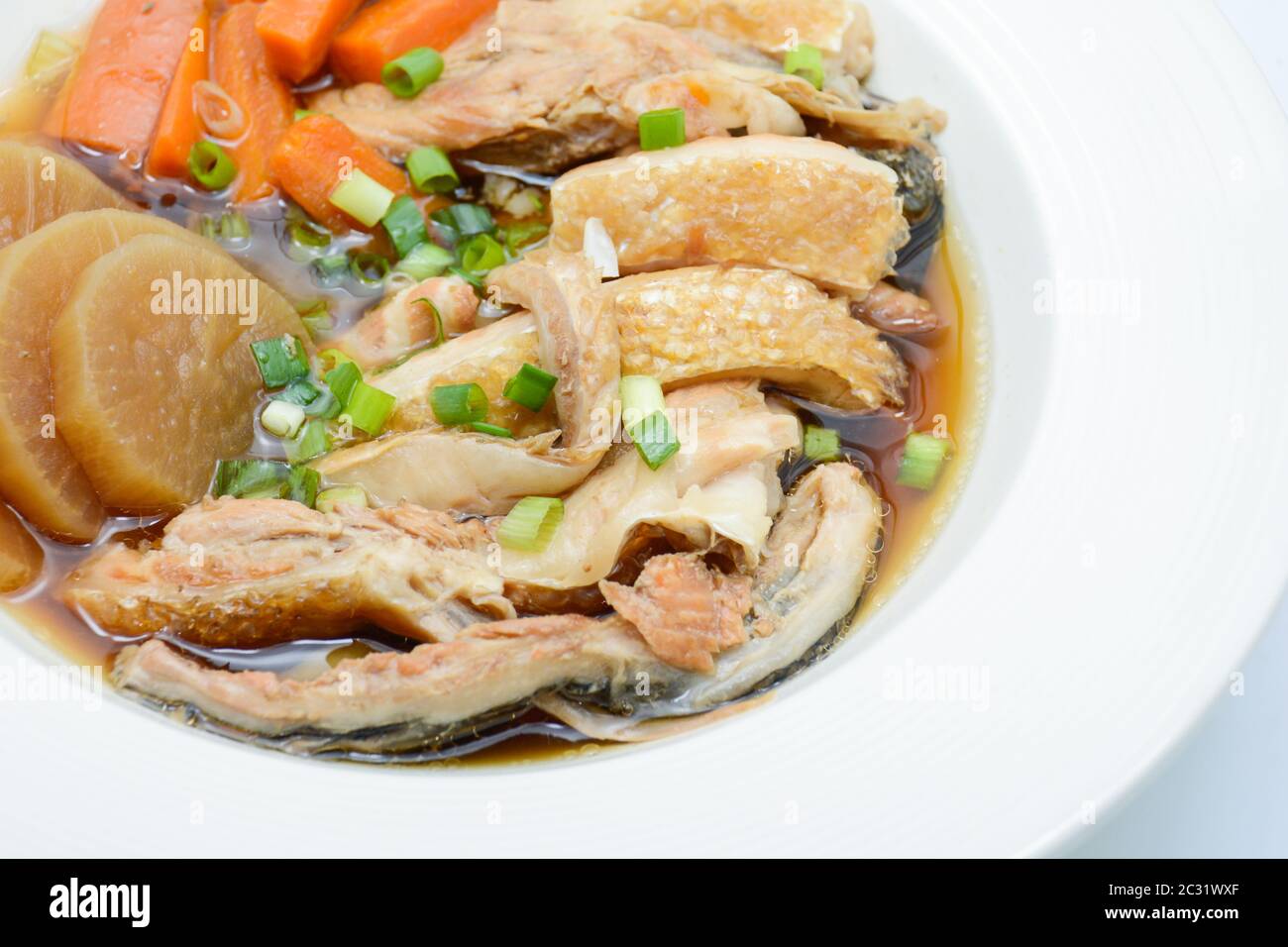 Salmon in soy source with vegetables, fish maw soup Stock Photo - Alamy
