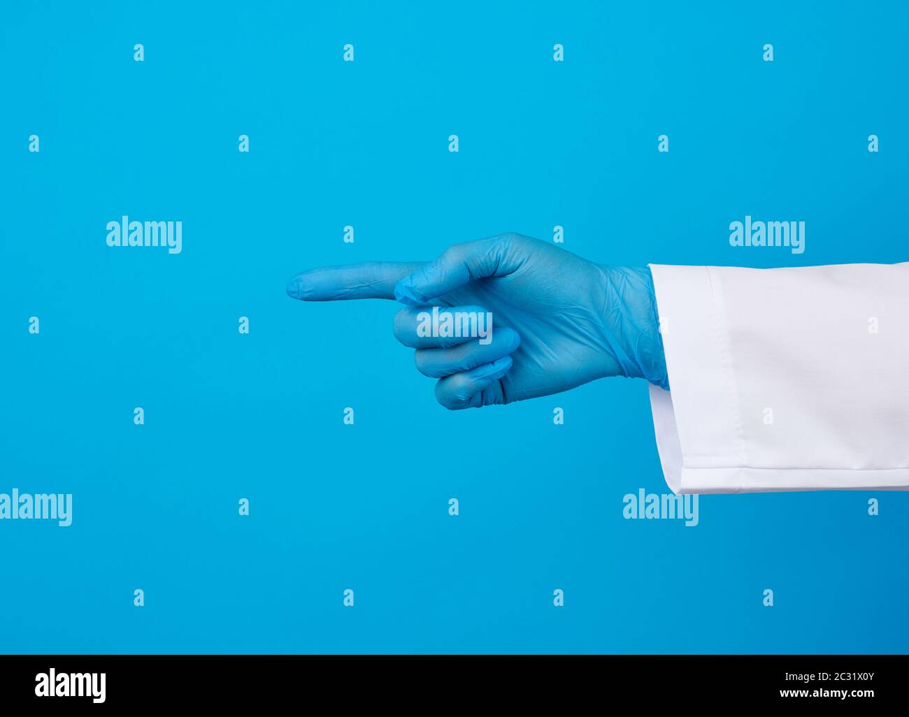 medic woman in white coat, wearing in blue sterile gloves, showing hand ...