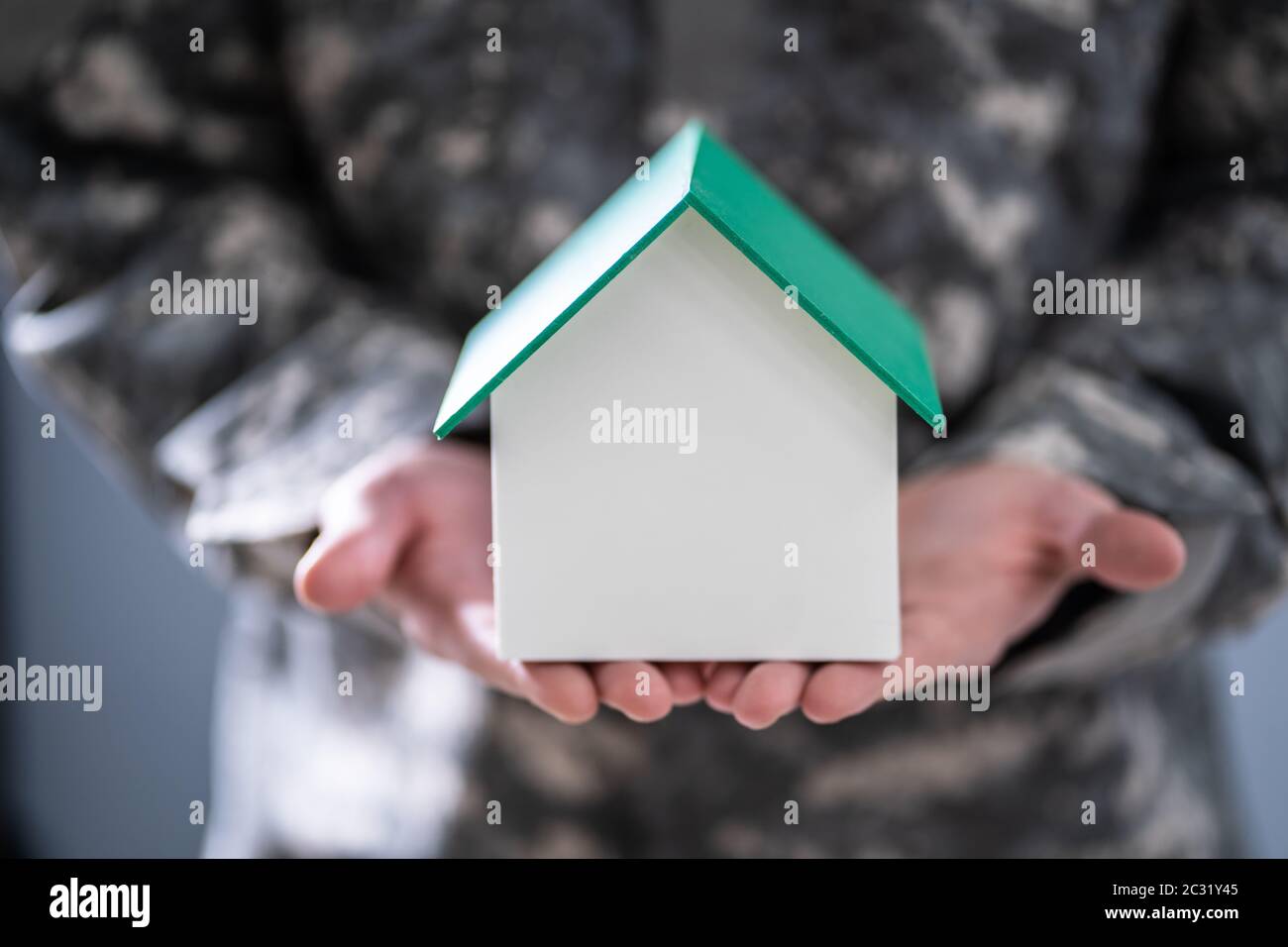 Mid Section Of Soldier Holding Model House In Hand Stock Photo - Alamy