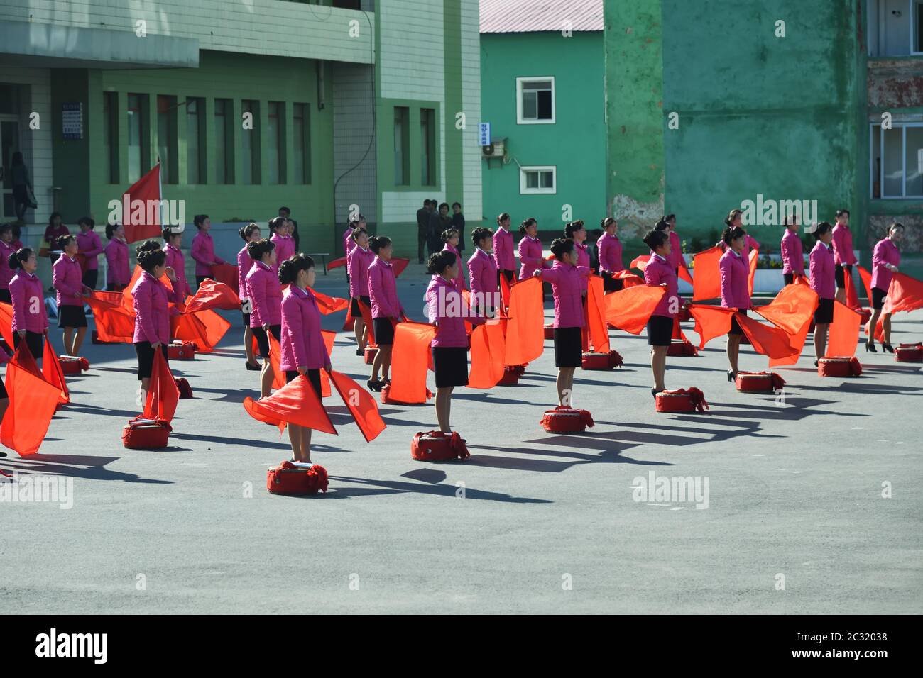 Pyongyang, North Korea - May 2, 2019: Girls with red flags perform ...