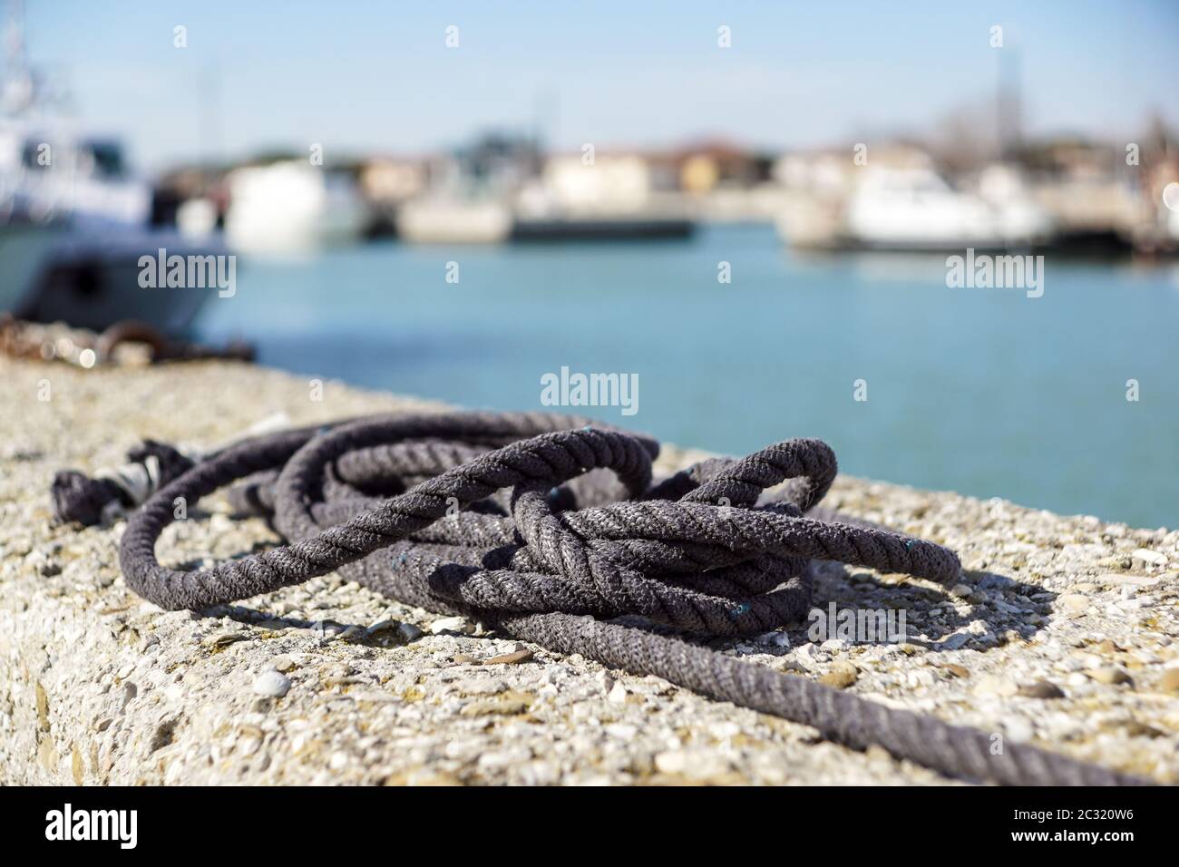 A white sailing rope on a wharf pier Stock Photo - Alamy