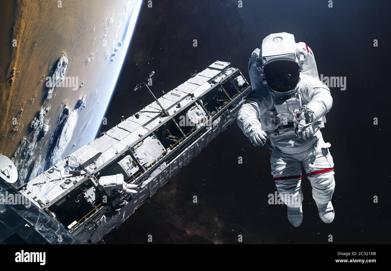 Astronauts, space station in orbit of planet Earth. Solar system Stock ...