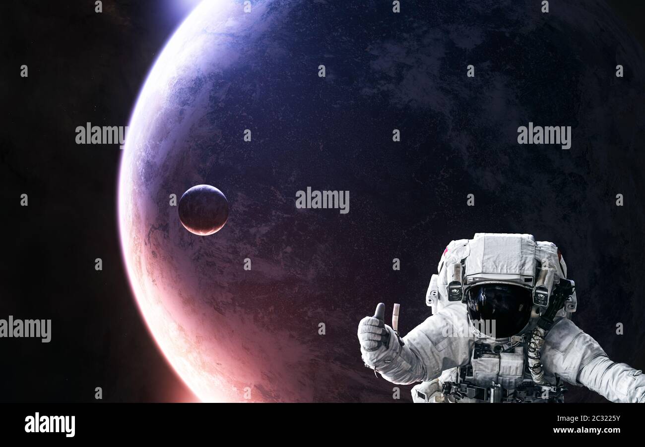 Planets of deep space in light of red and blue stars. Astronaut on ...