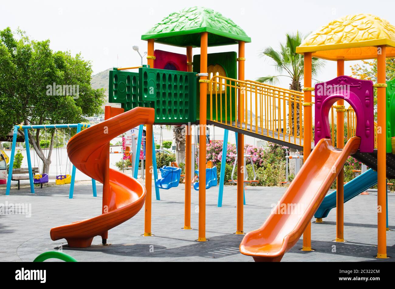 Colorful children playground activities in public park surrounded by ...