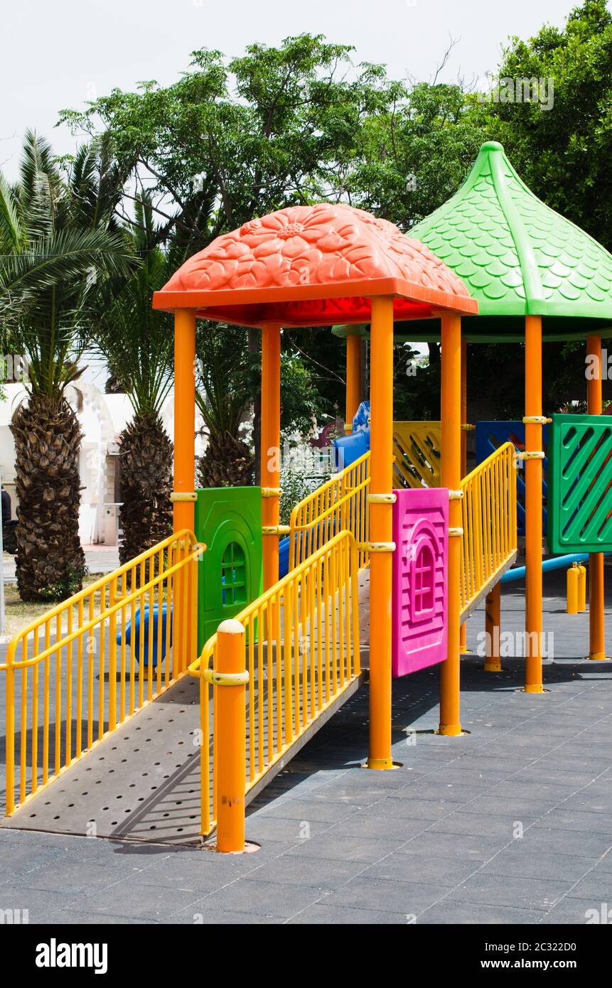 Colorful children playground activities in public park surrounded by ...