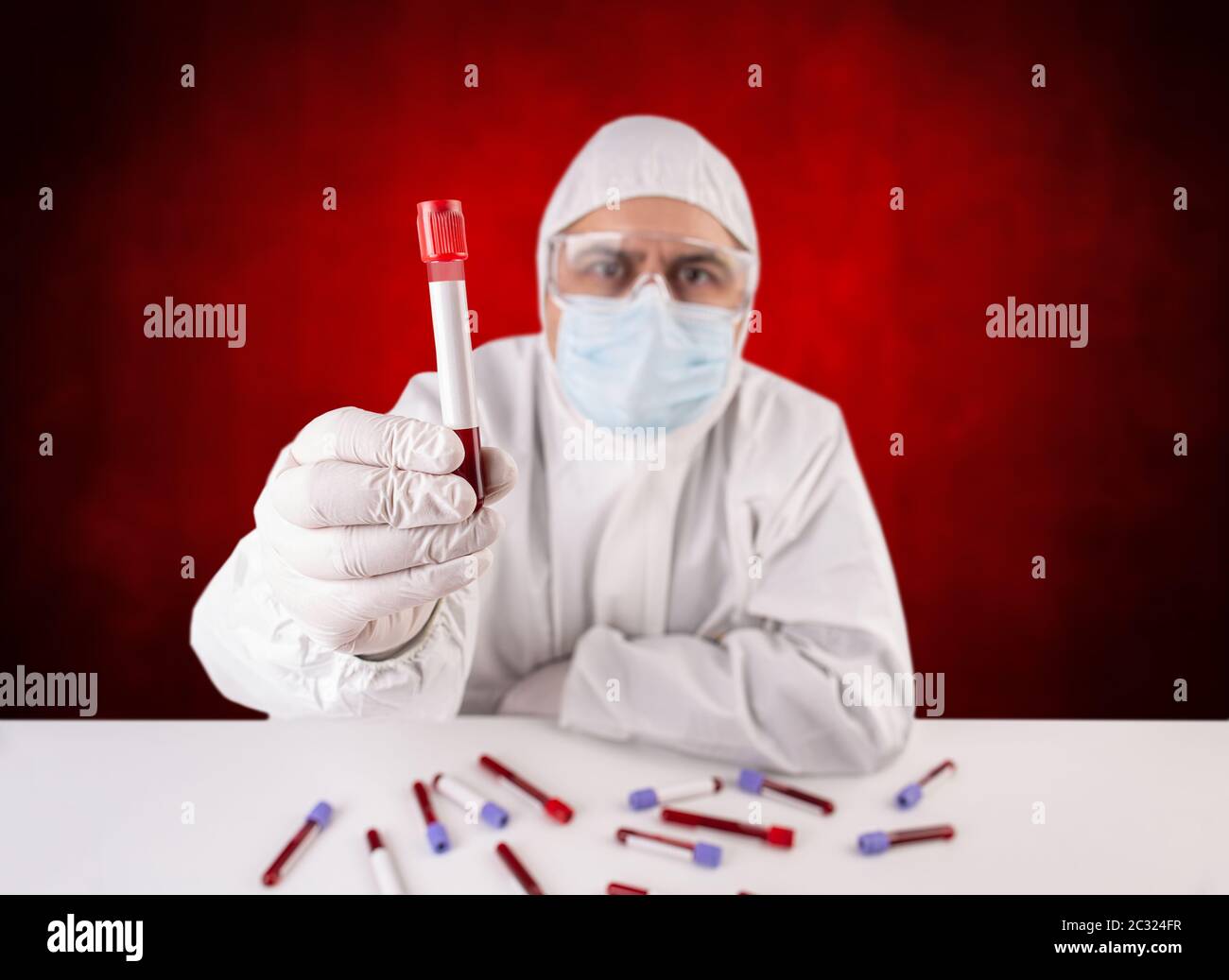 Lab worker holding test tube with blood sample on red background Stock ...