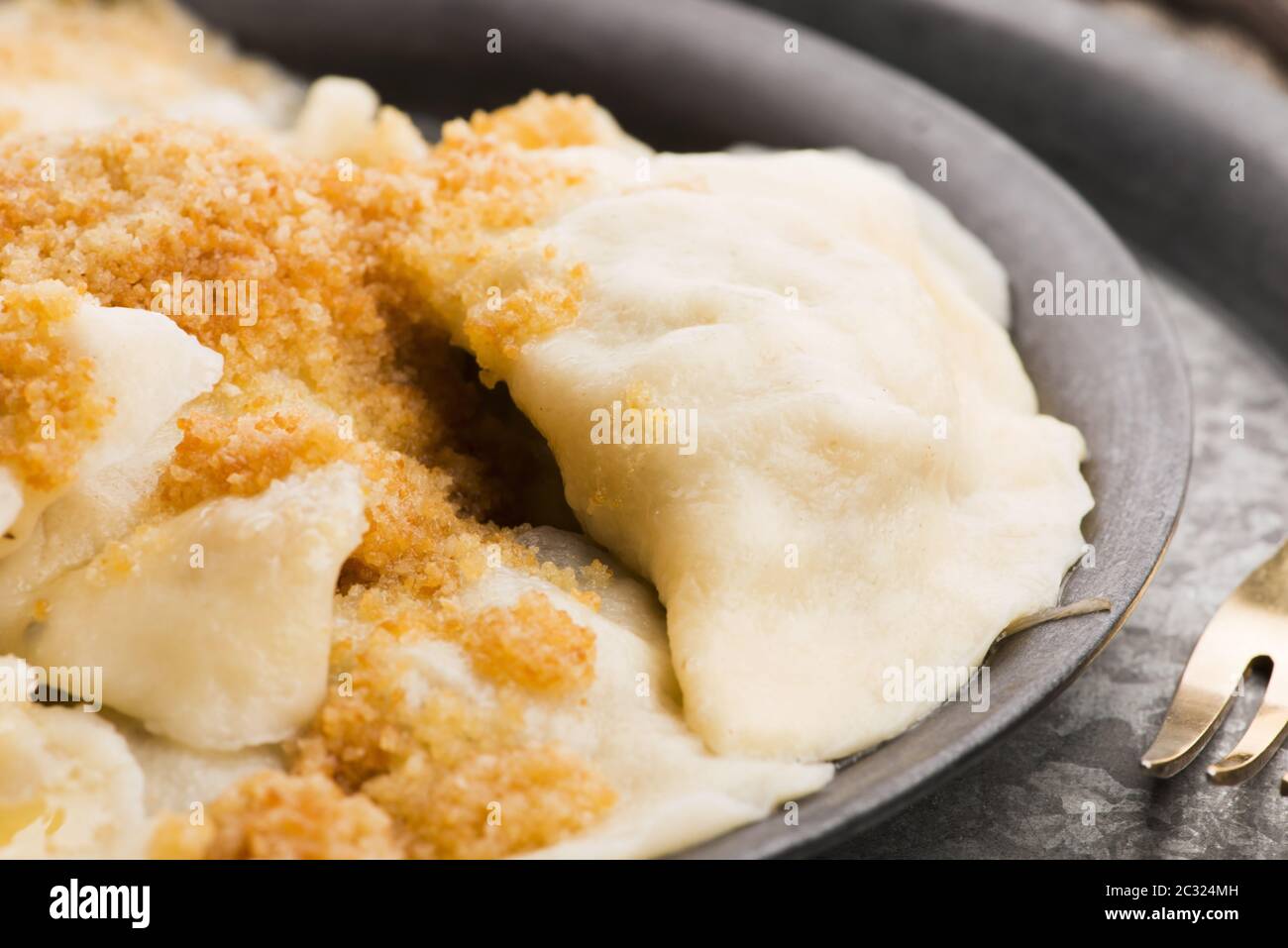 Boiled pierogi (Polish dumplings) stuffed with cabbage and mushrooms ...