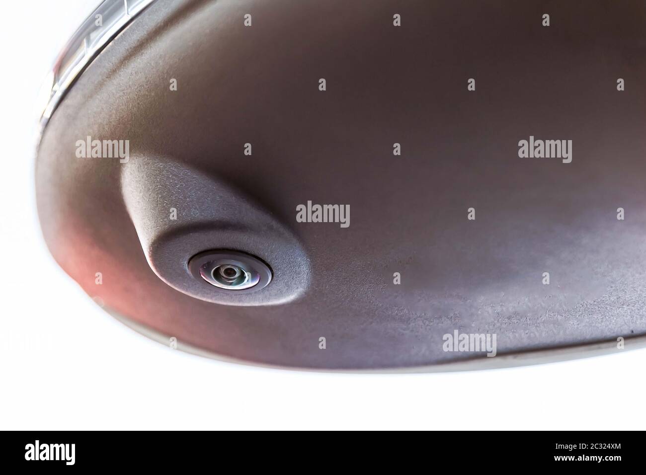 Black lower part of the rearview mirror with a circular camera. Left ...
