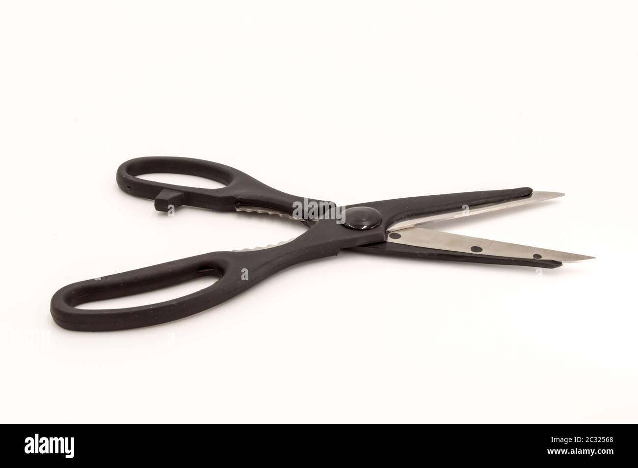Kitchen scissor with a black handle, isolated on a white background ...