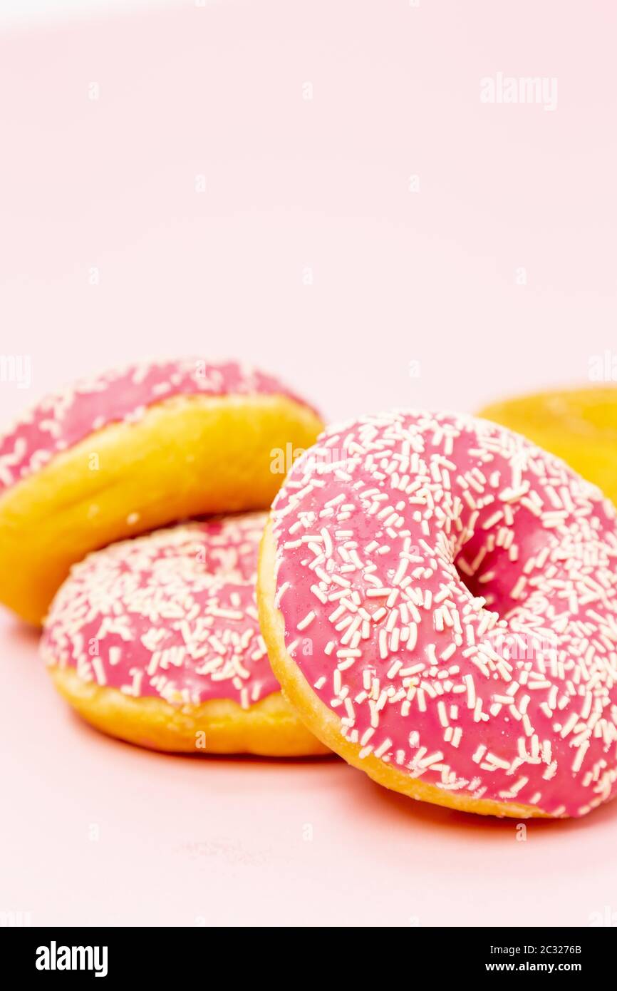 Pink iced donut hi-res stock photography and images - Alamy