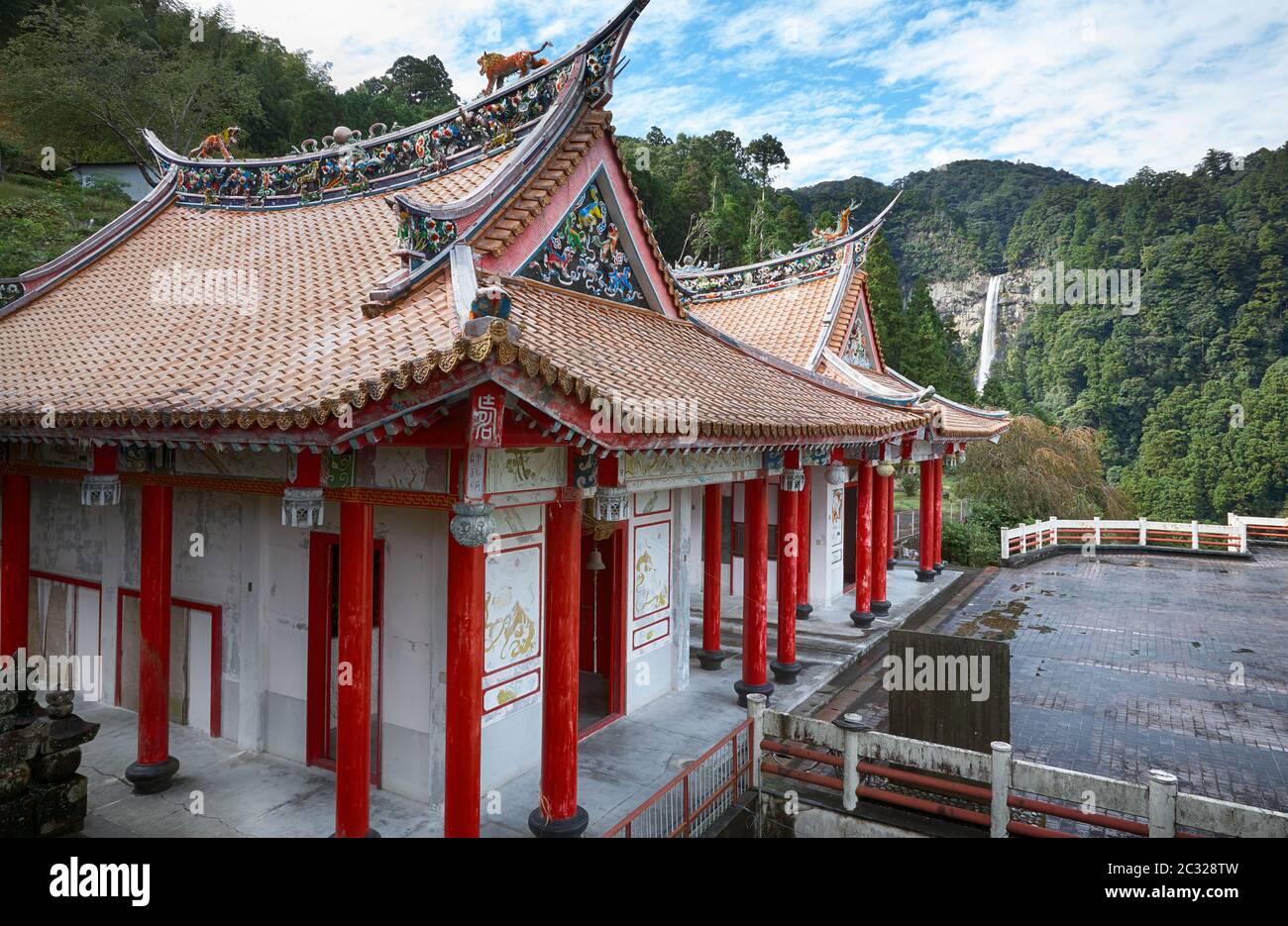 The colorful Chinese temple with the Nachi waterfalls on the background ...