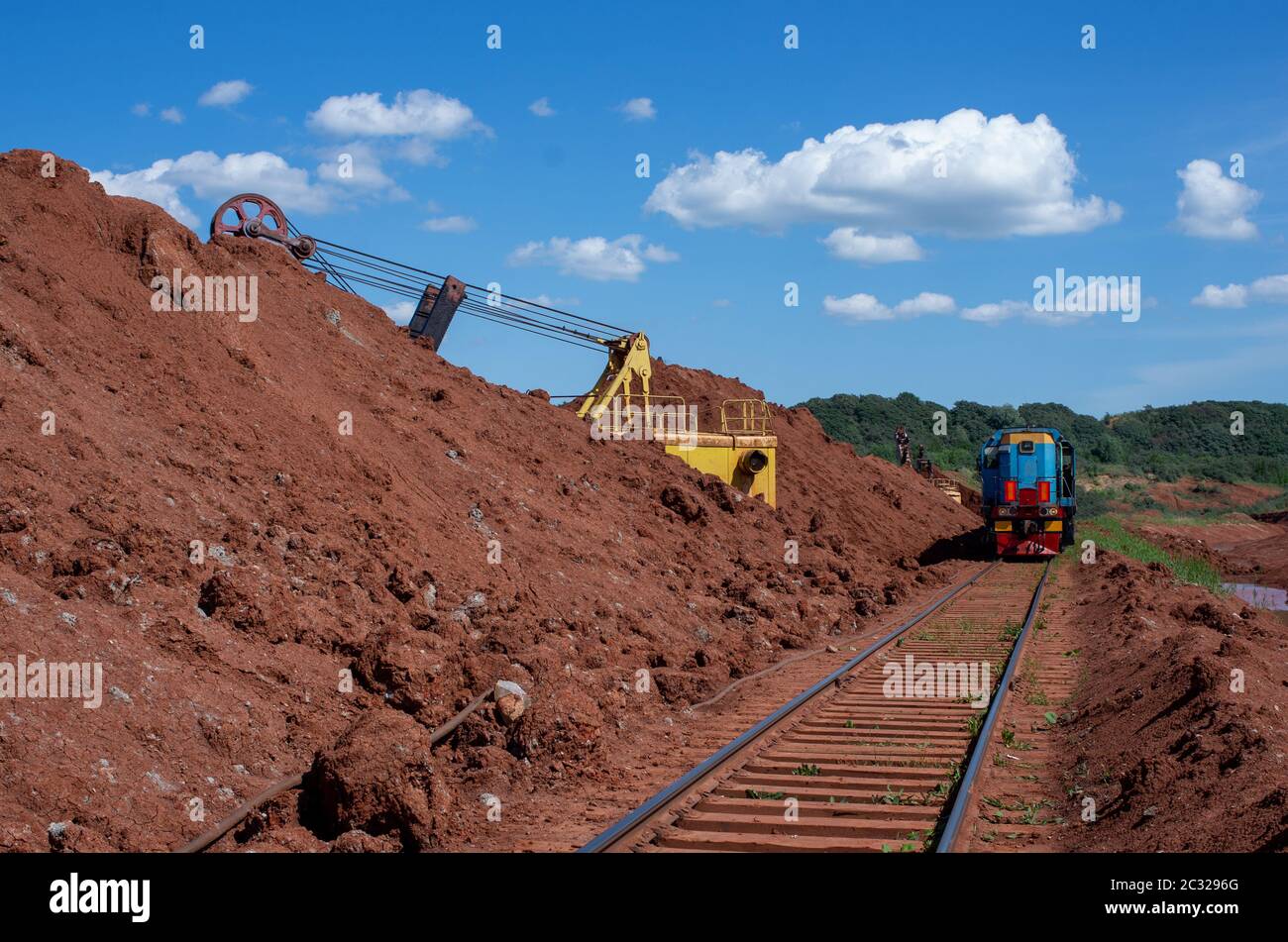 Excavator loading clay to the train on the opencast mining site Stock ...