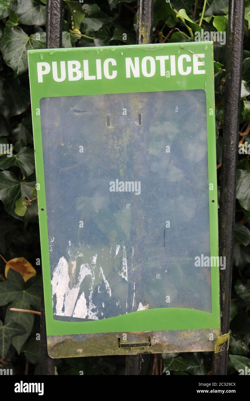 Green public notice sign empty and without any contents attached to a ...