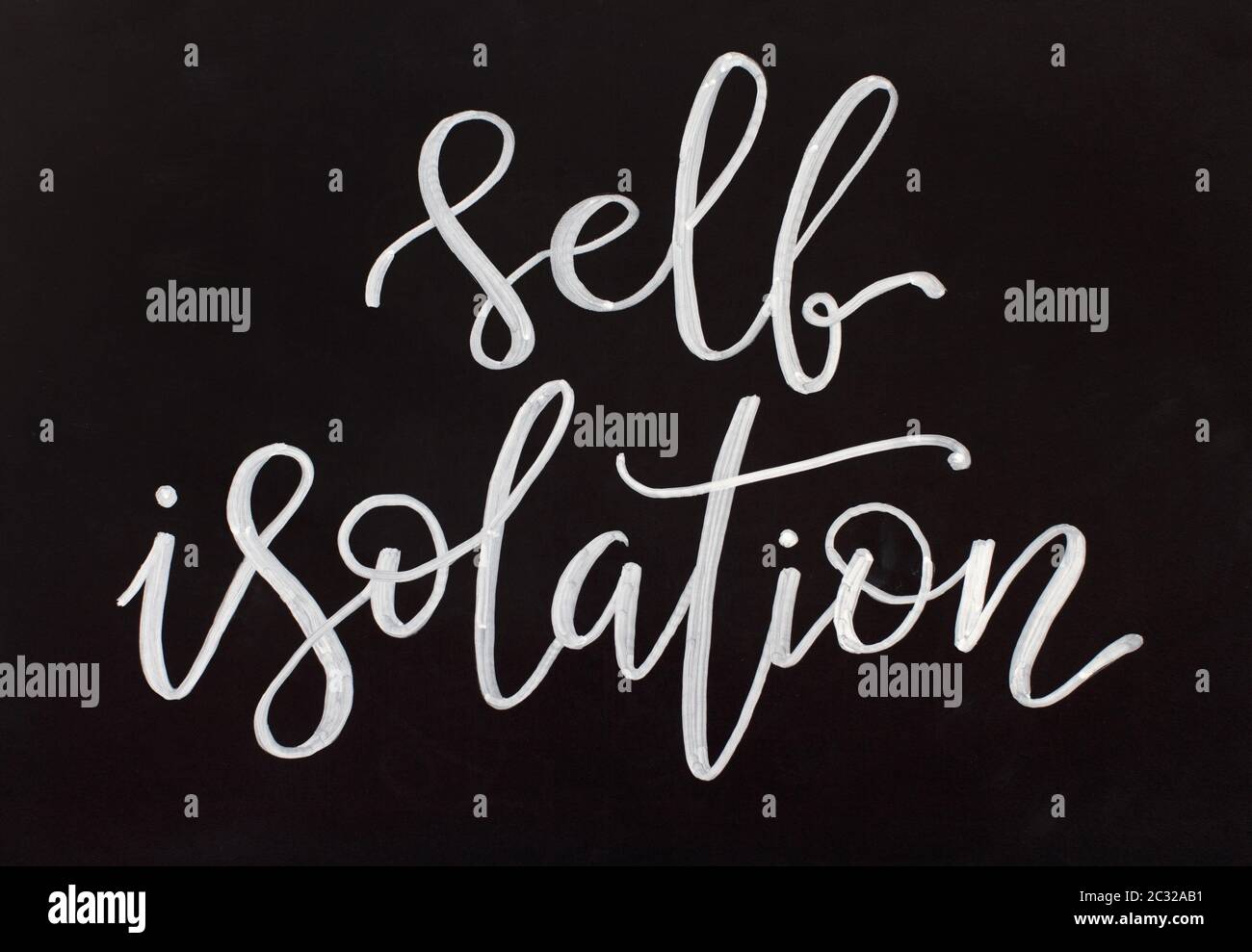 Chalk inscription SELF ISOLATION on a black chalkboard. Handwritten ...
