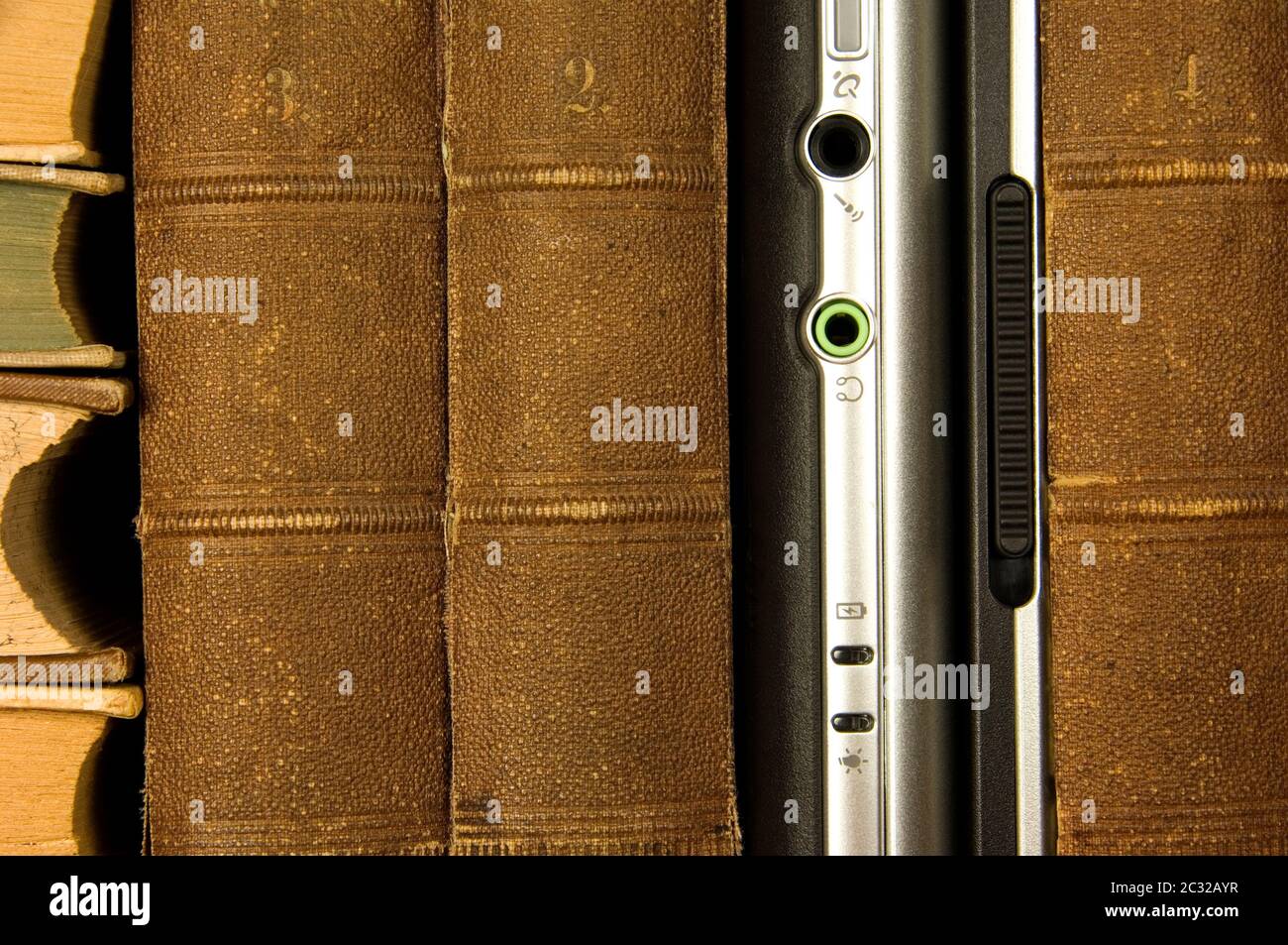 Laptop standing between very old books like in a library Stock Photo ...