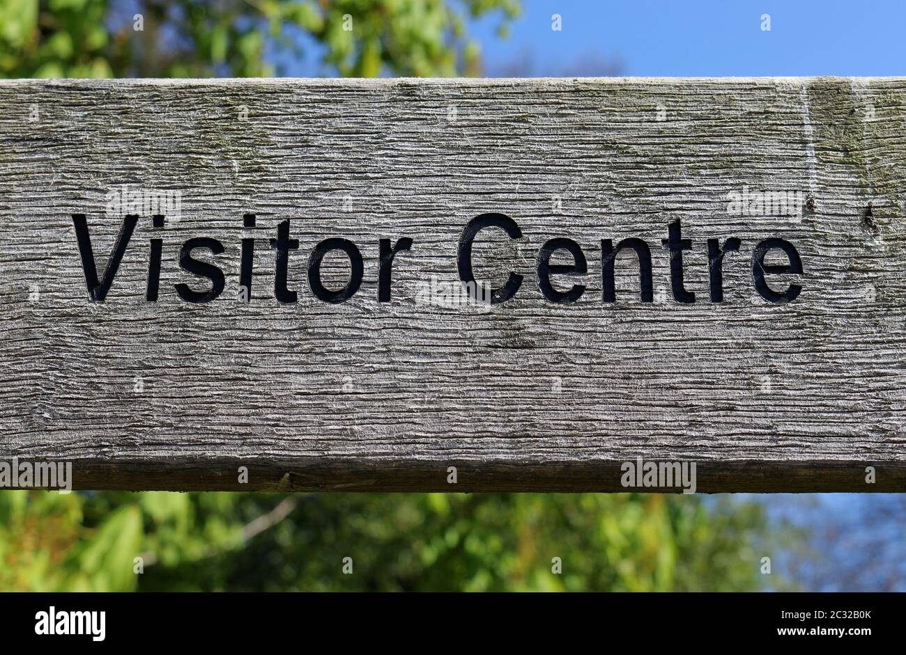 Routed wooden rustic visitor centre sign with the lettering inlaid in ...