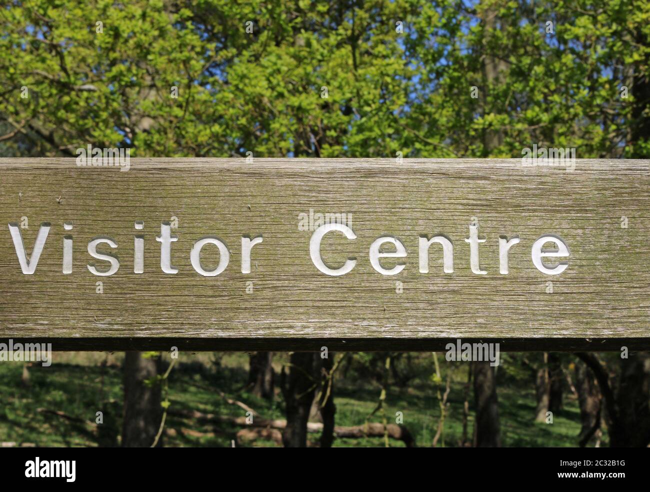 Routed wooden rustic visitor centre sign with the lettering inlaid in ...