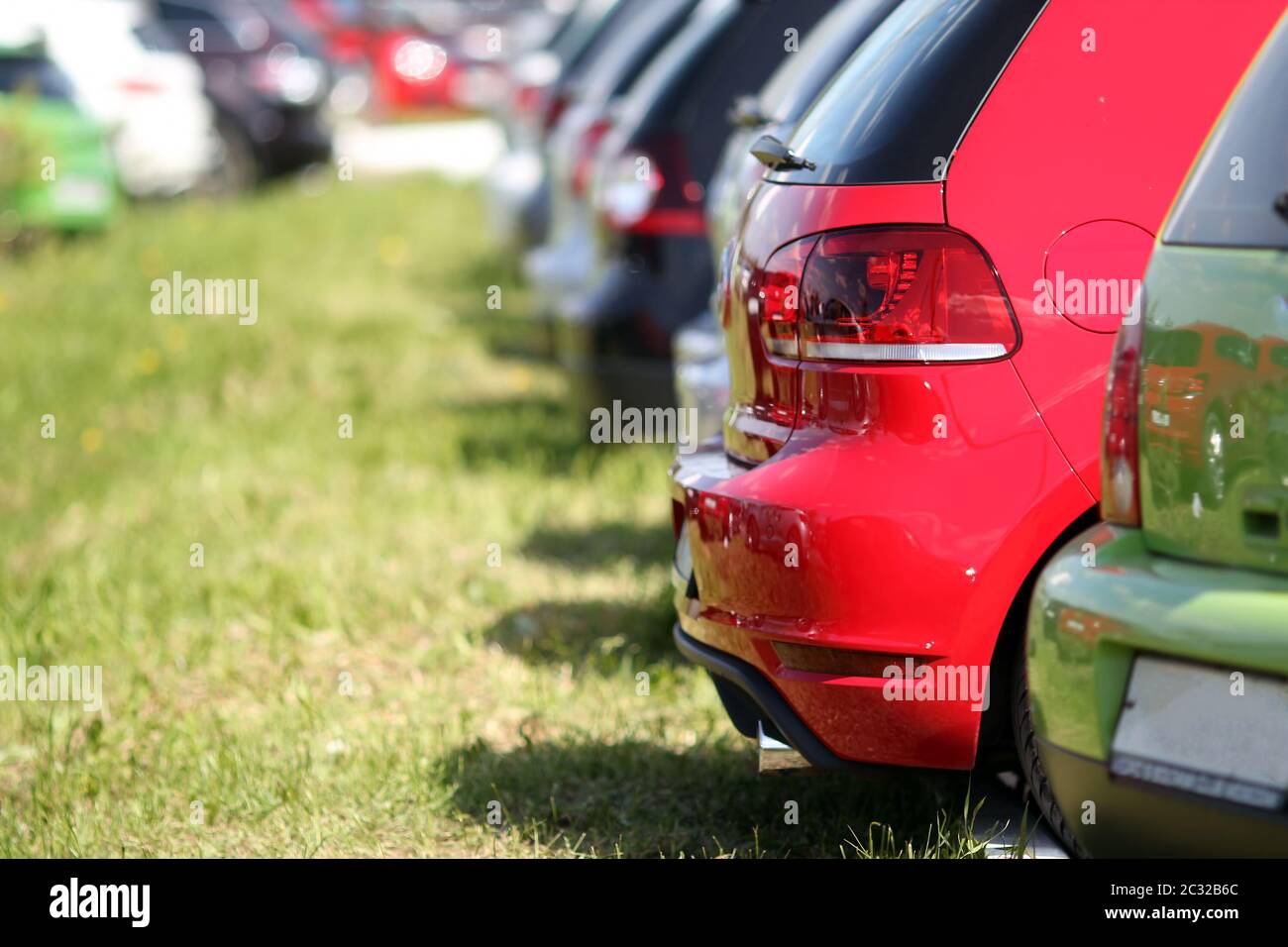 Colorful cars parked on the grass. Red and green automobiles Stock ...