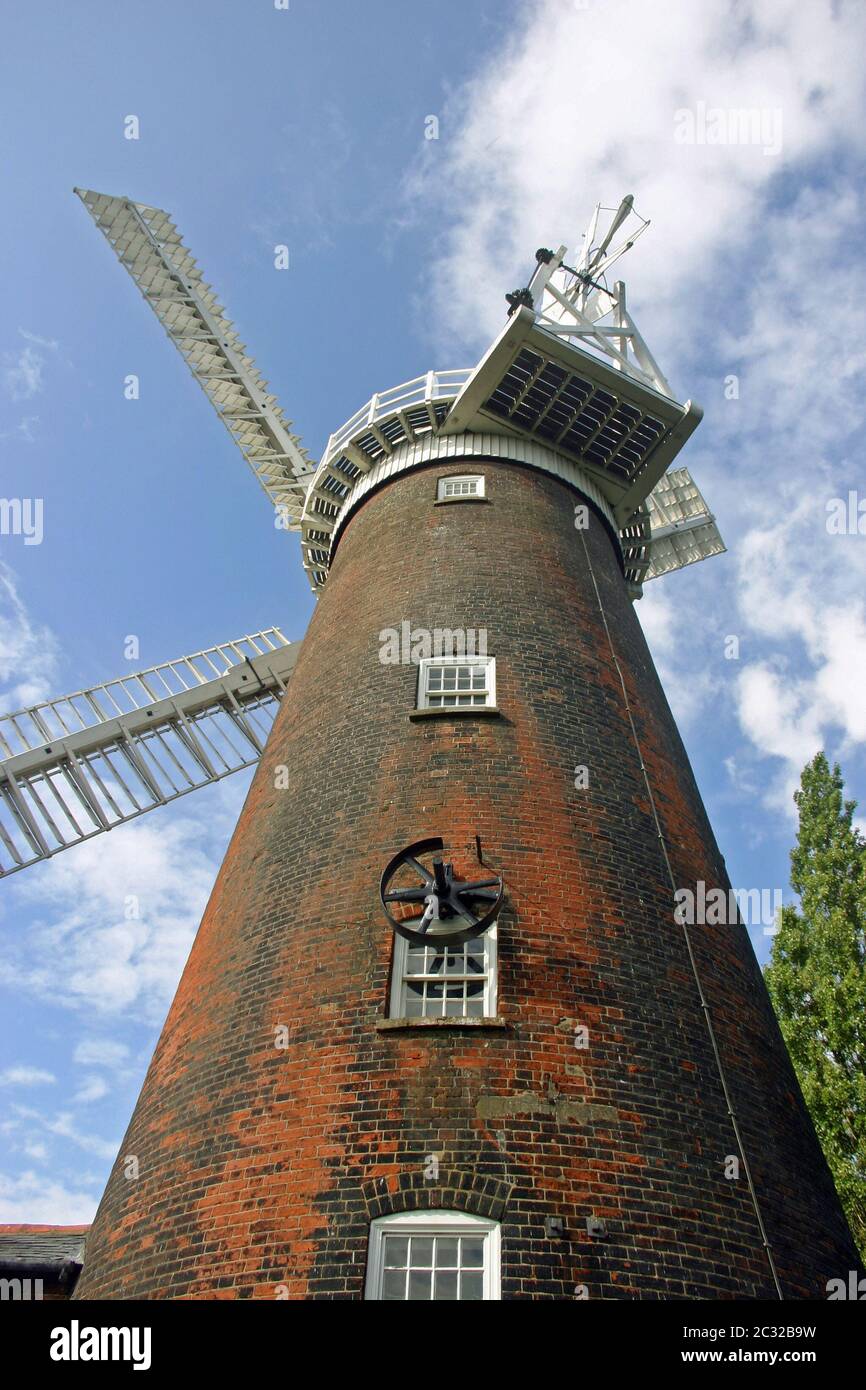 Brick faced windmill seen from below looking up at three sails with a ...