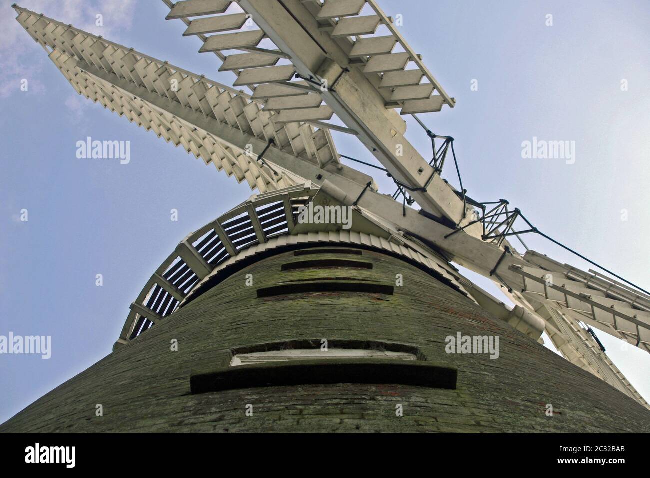 Windmill seen from below looking at the four sails on the cap up a row ...