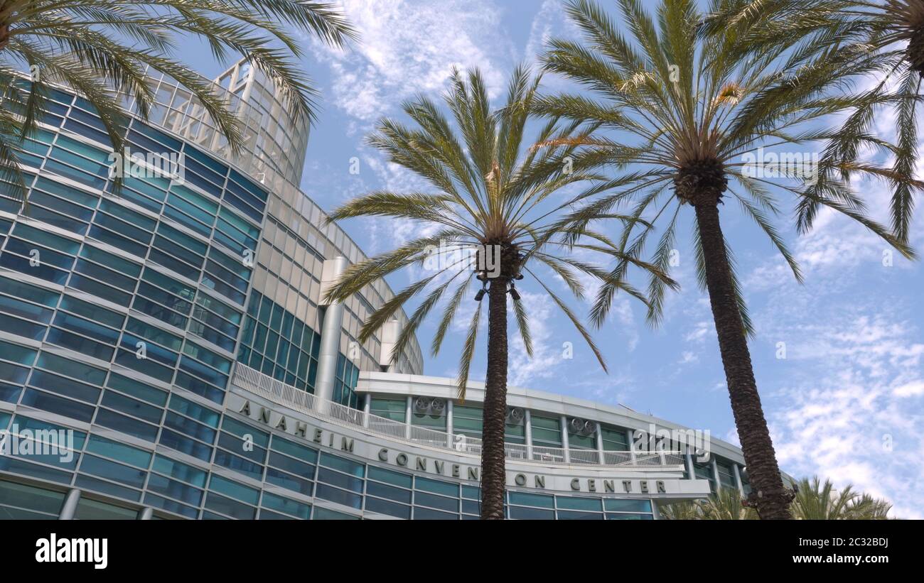 View of the Anaheim Convention Center framed by palm trees on a ...