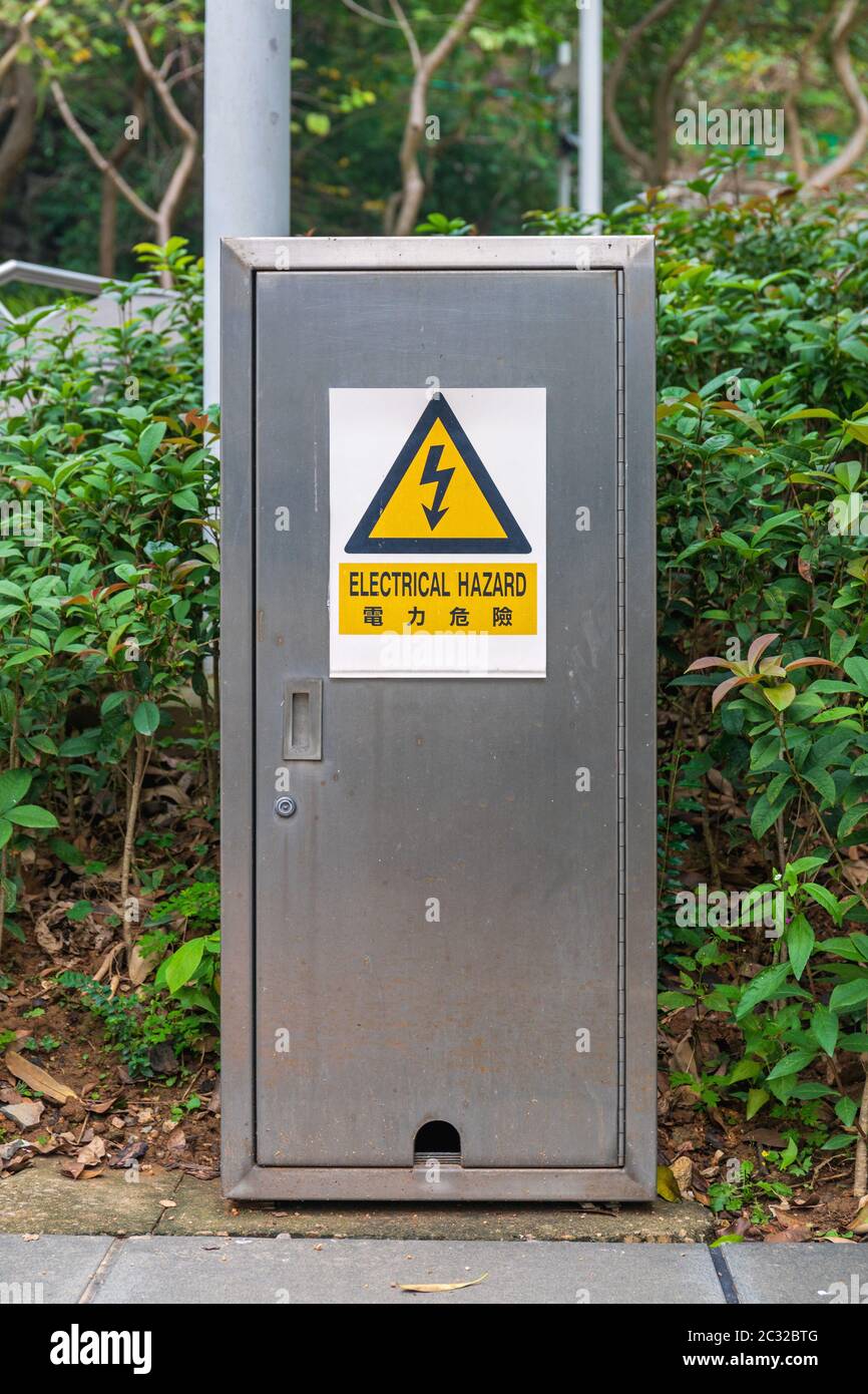 Electric Hazard Sign at Power Box in Park Stock Photo - Alamy