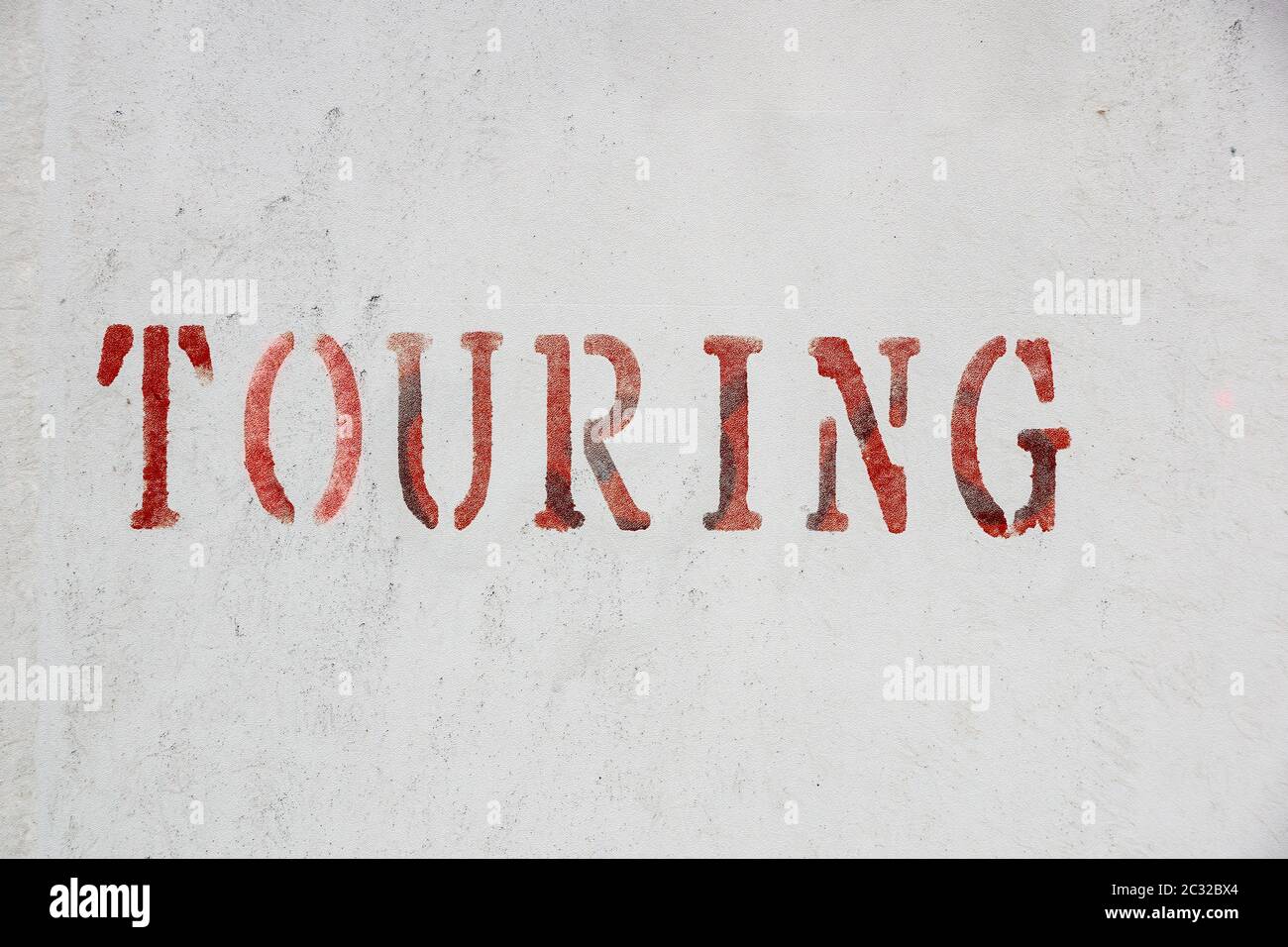 touring sign written on wall . close up Stock Photo - Alamy