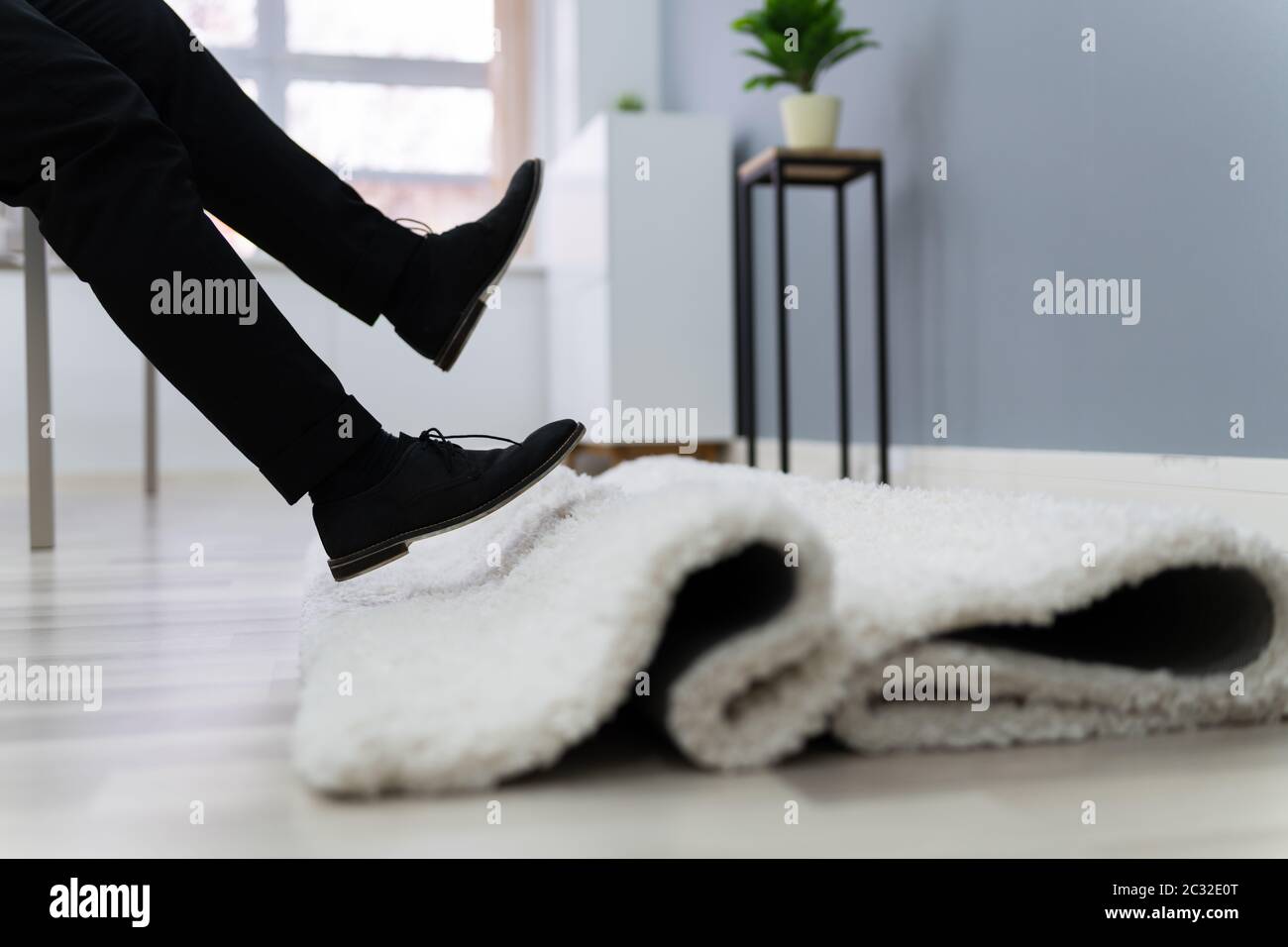 Low Section Of Man Legs Stumbling With A Carpet In The Living Room At ...