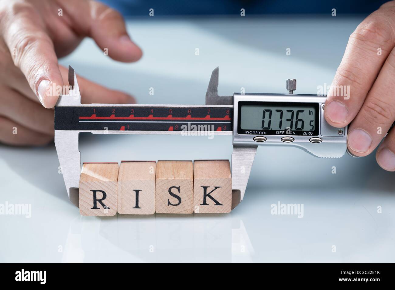 Close-up A Person's Hand Measuring Wooden Risk Blocks With Digital ...