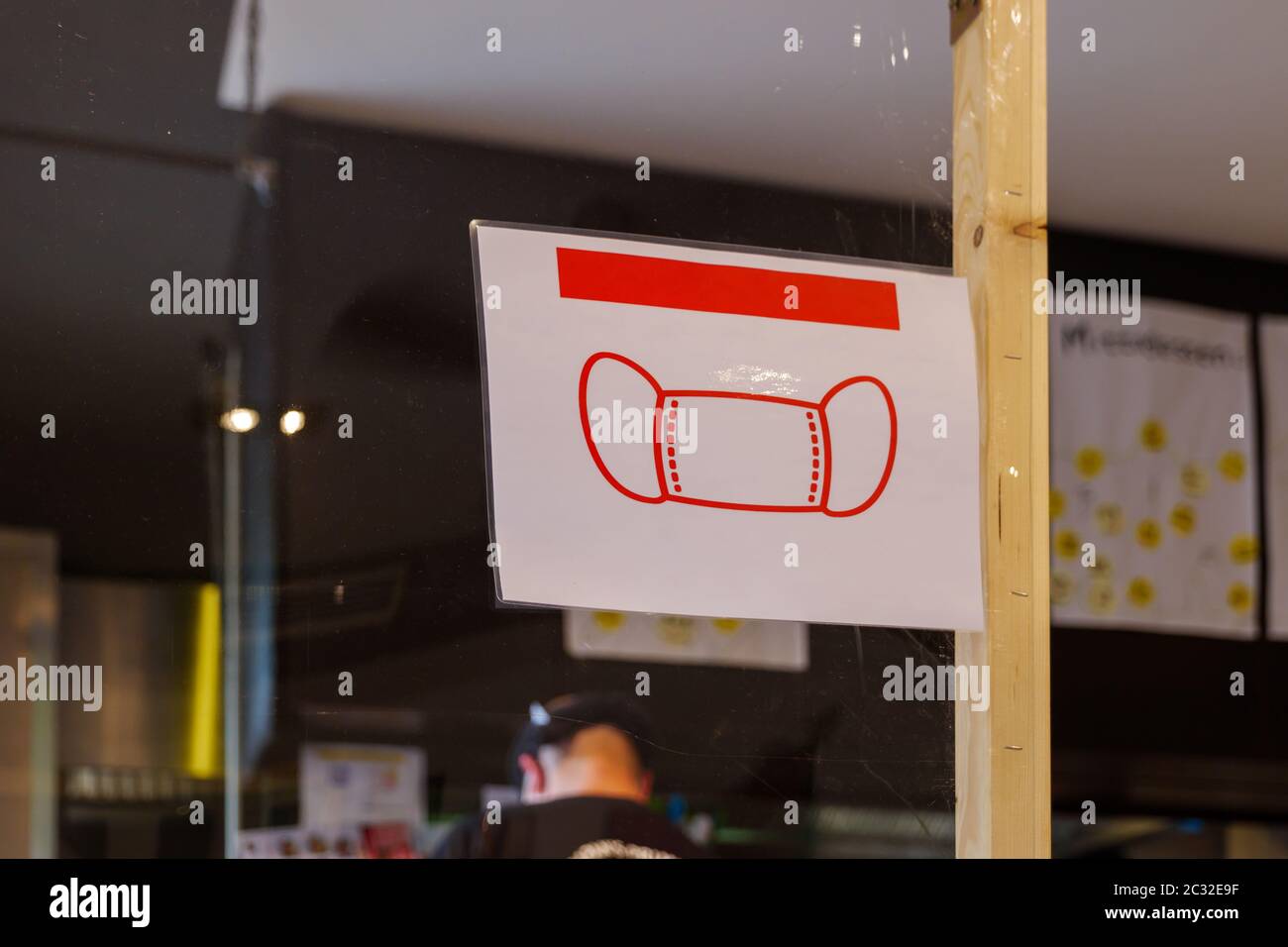 Face mask covering mouth and nose symbol on white sign on temporary ...