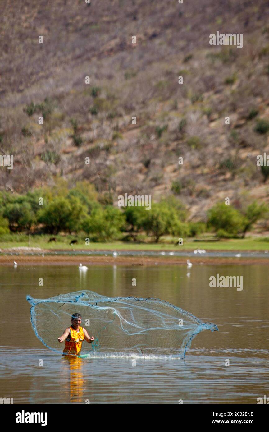 A fisherman spreads his net in the Infiernillo Dam of Michoacan, Mexico ...