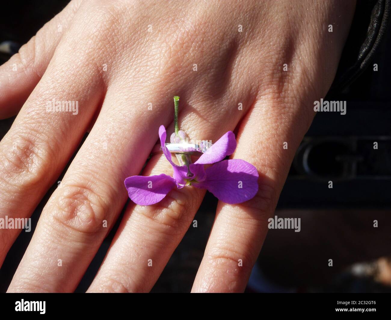 Floral ring on female hand Stock Photo - Alamy