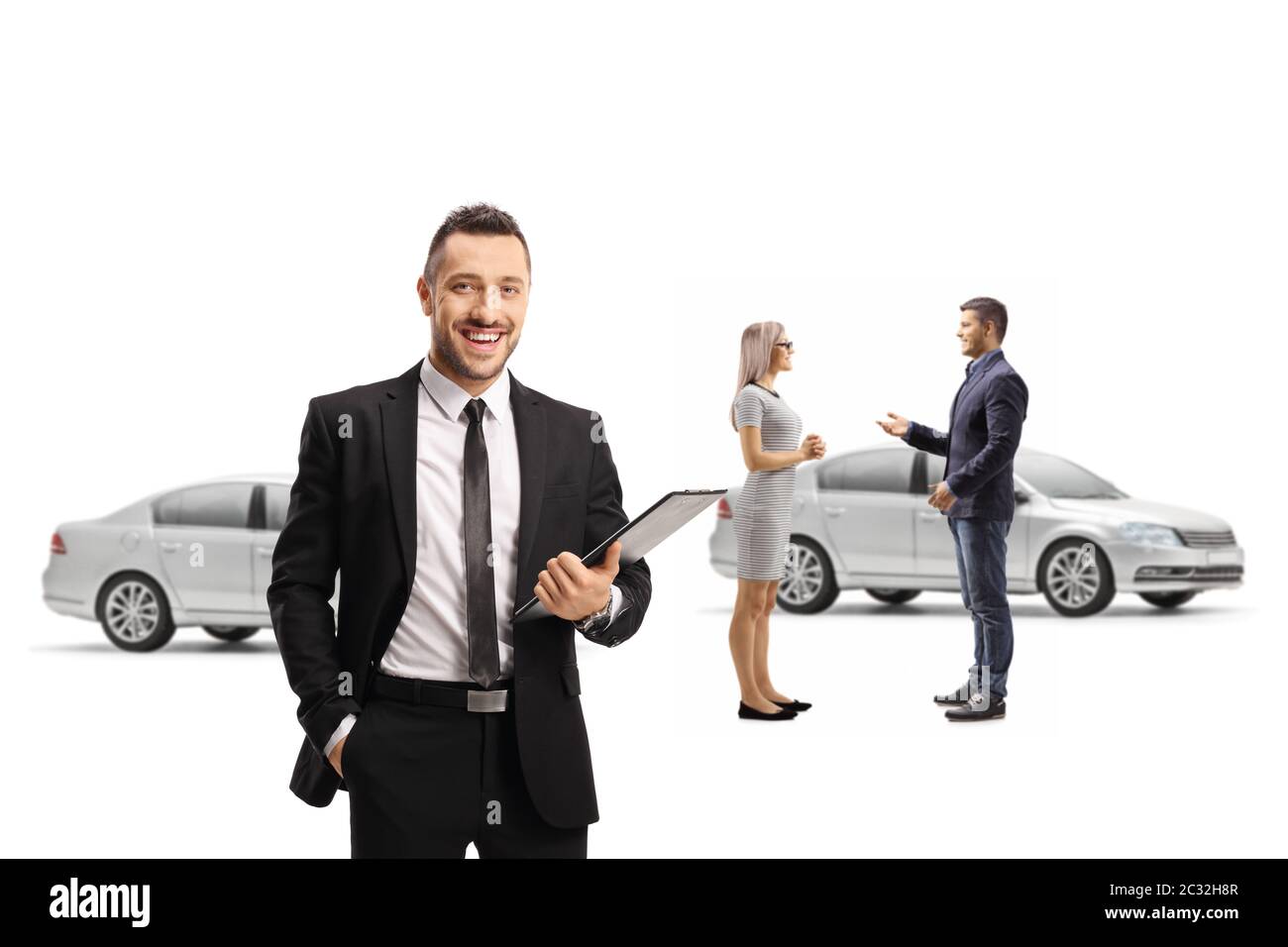 Manager in a car showroom and a man and woman customers talking ...