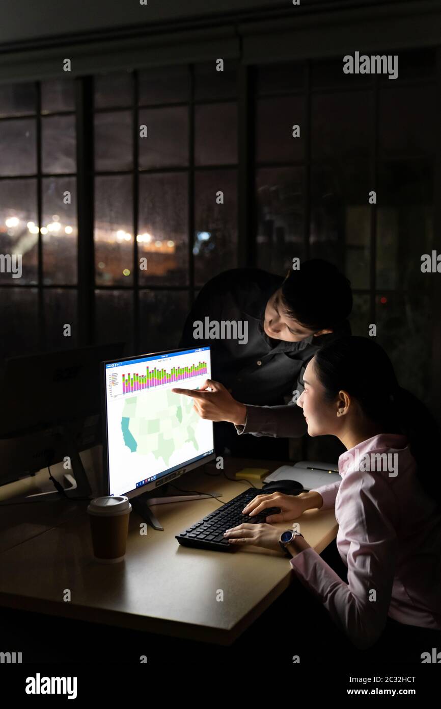 Teamwork working Late at night Stock Photo - Alamy