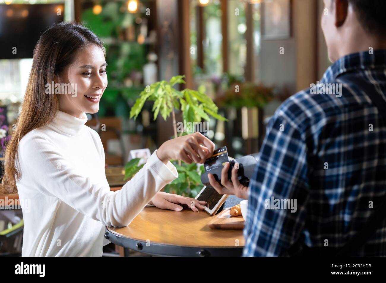 Cafe payment using swipe credit card Stock Photo - Alamy