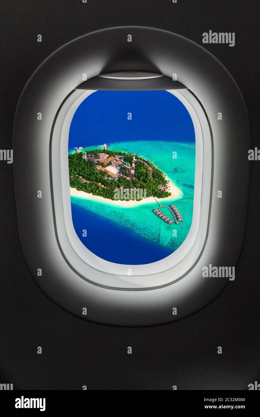 Tropical island at Maldives in airplane window Stock Photo - Alamy