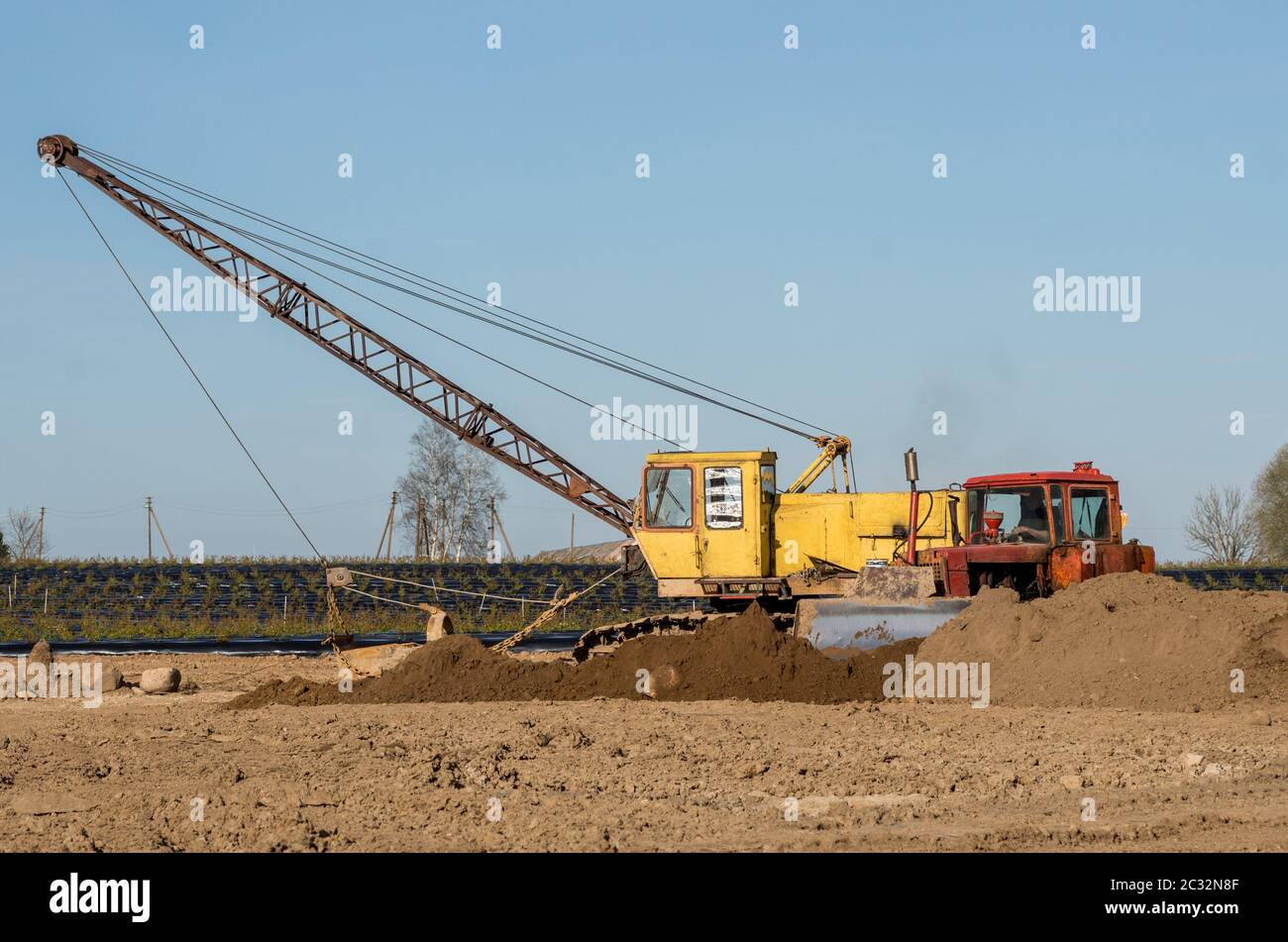 Tractor and excavator stay in the after hard work Stock Photo - Alamy