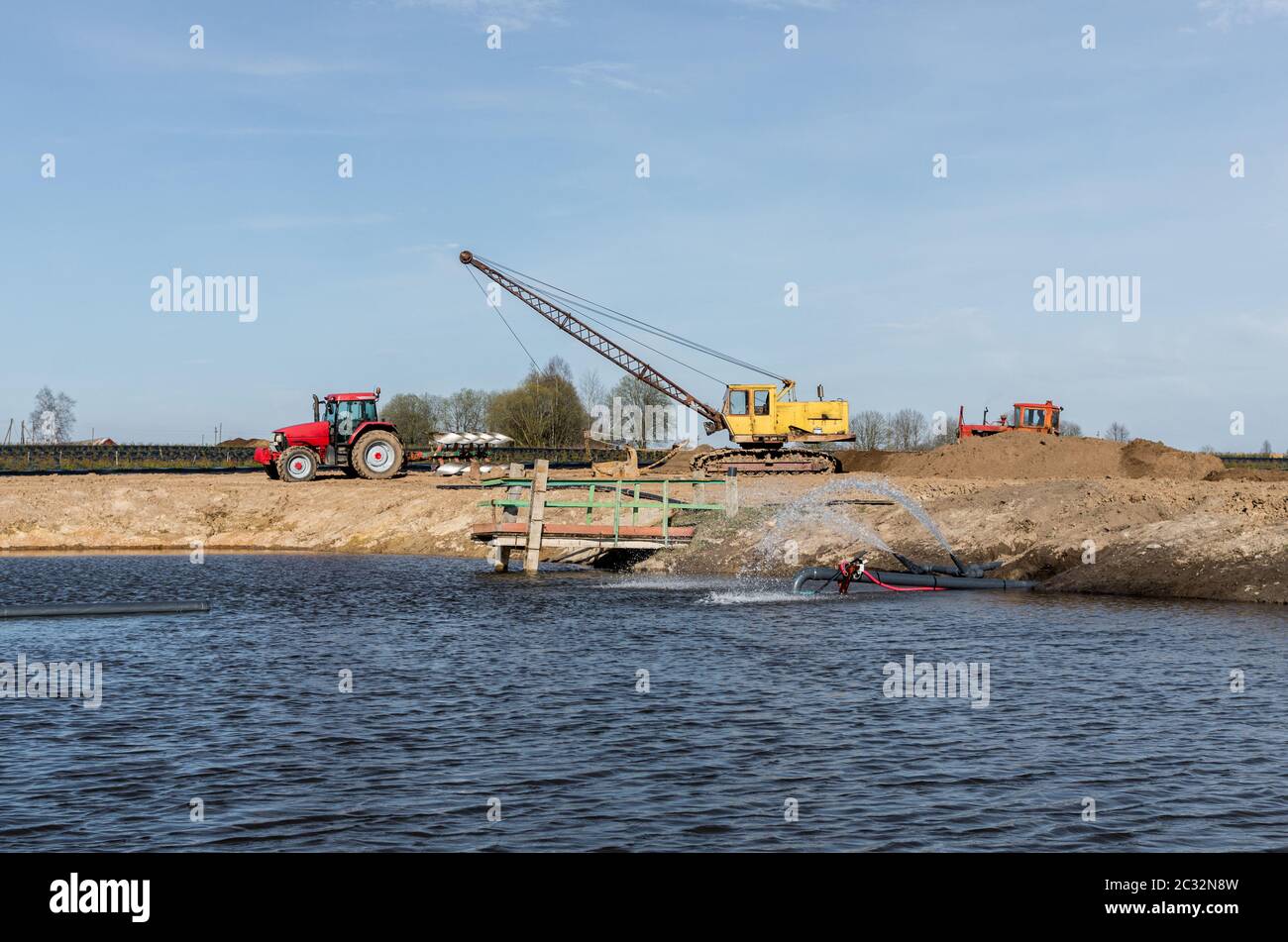 Tractor and excavator stay in the after hard work Stock Photo - Alamy