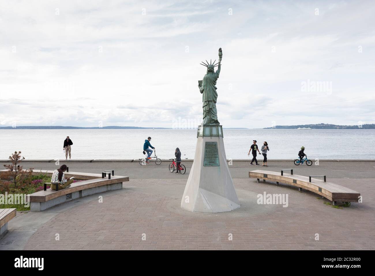 Visitors enjoy a sunny afternoon at Statue of Liberty Plaza in Alki ...