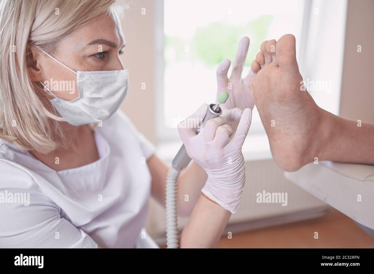 Podiatrist using grinding equipment and making procedure polish for ...
