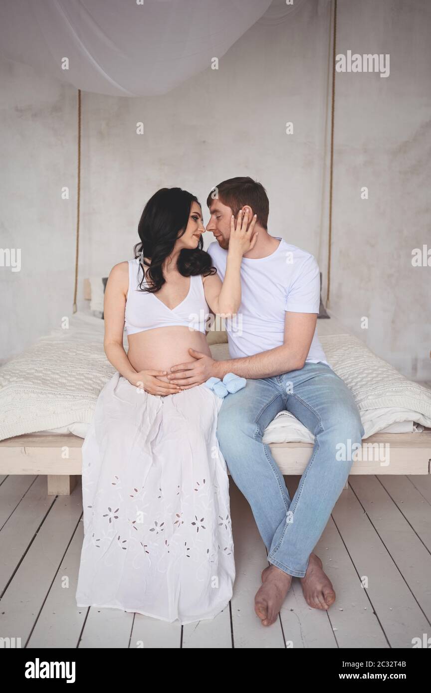 Pregnancy concept - happy man hugging his beautiful pregnant wife at ...