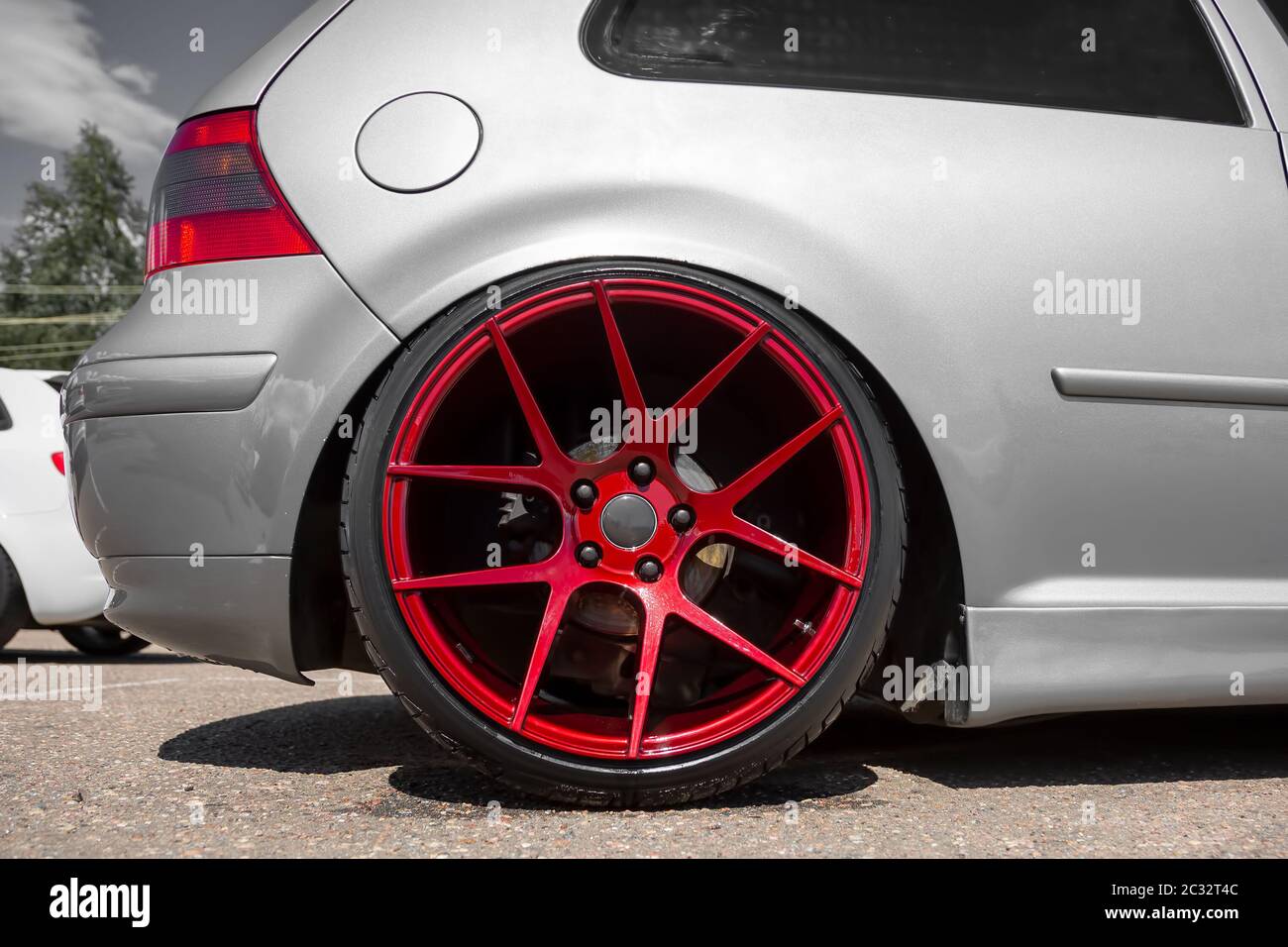 red candy colored light alloy wheels on silver hatchback Stock Photo ...