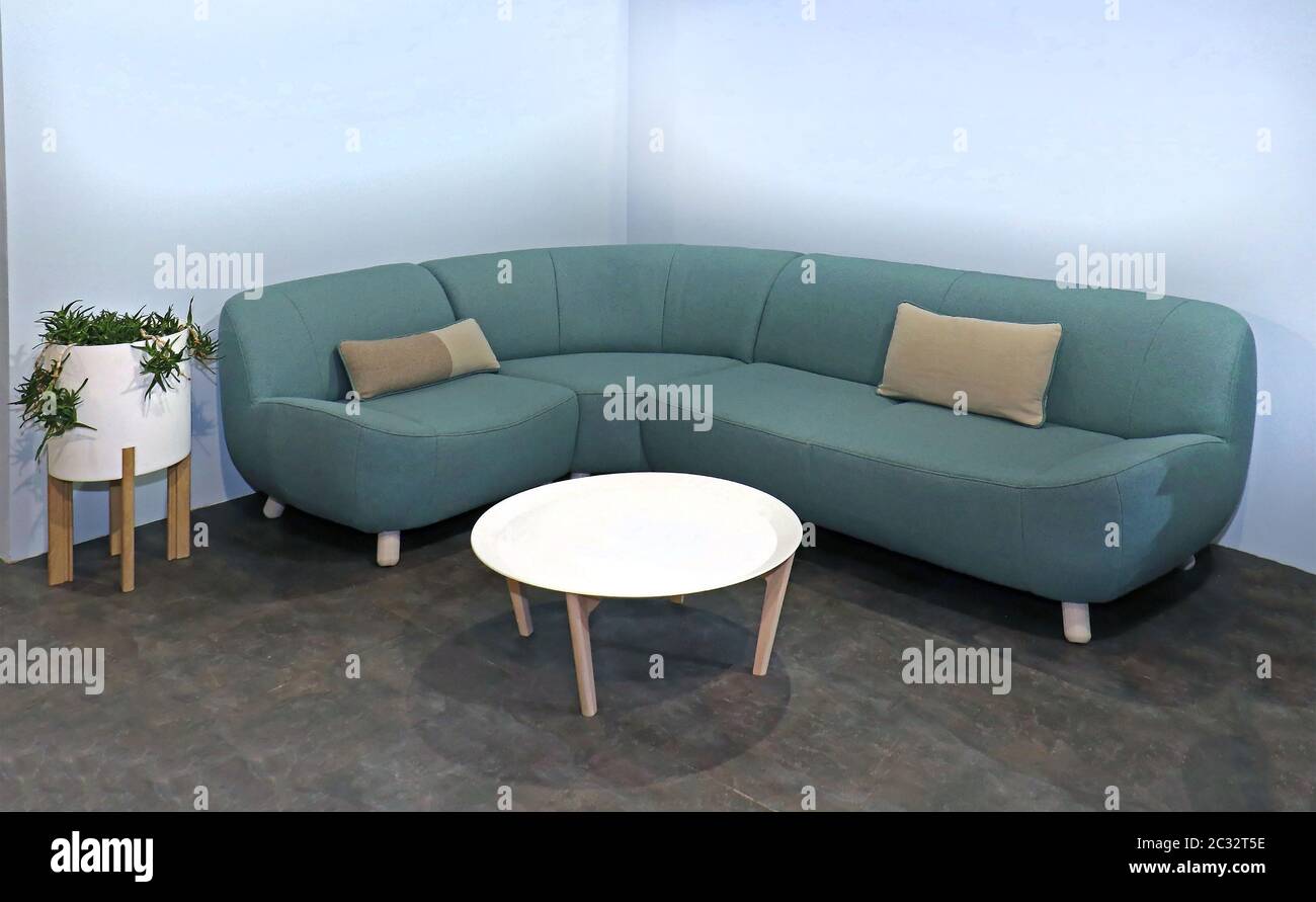 Corner sofa and small table inside modern interior Stock Photo - Alamy