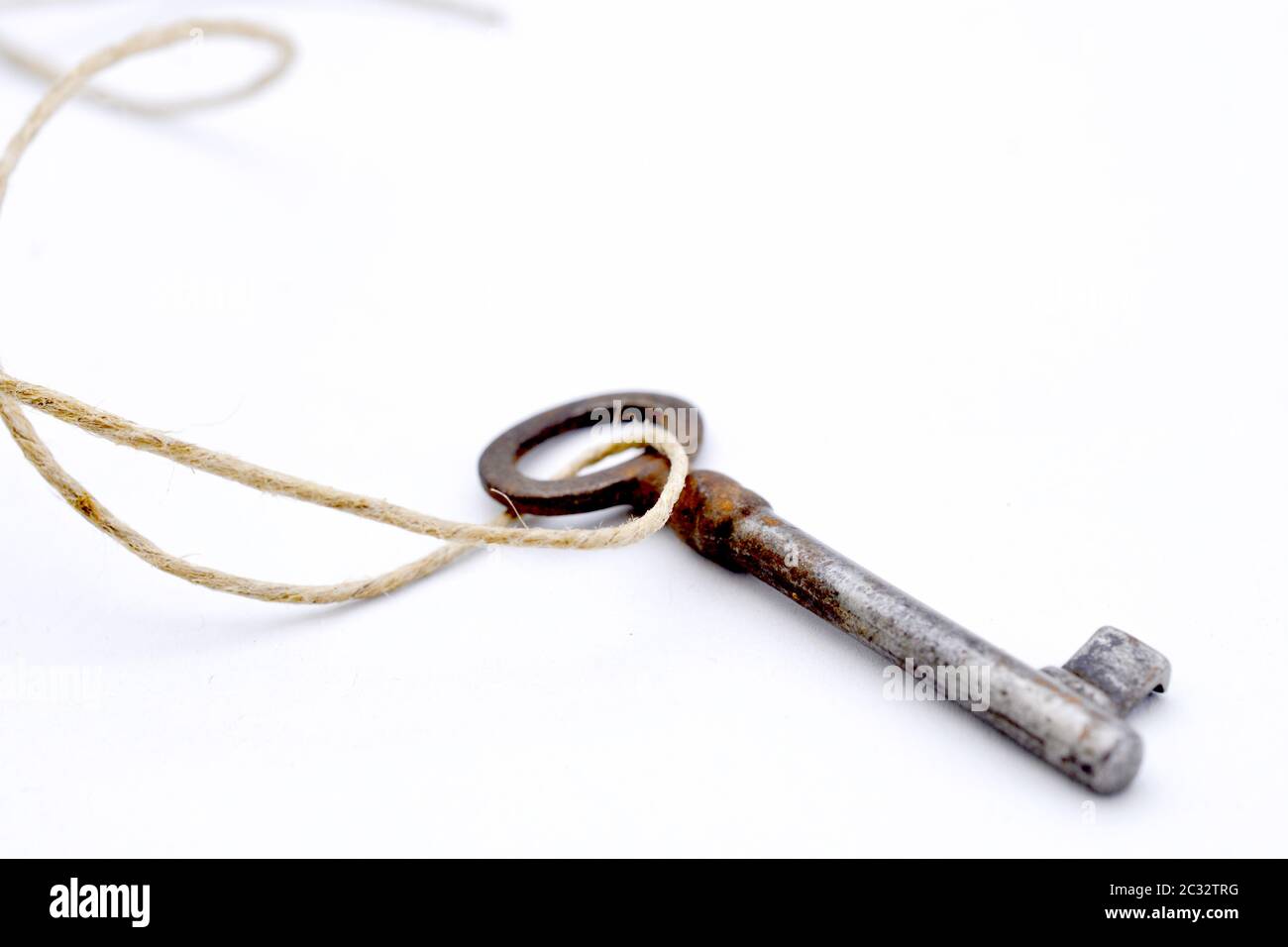 old rusty key on white background, image Stock Photo - Alamy